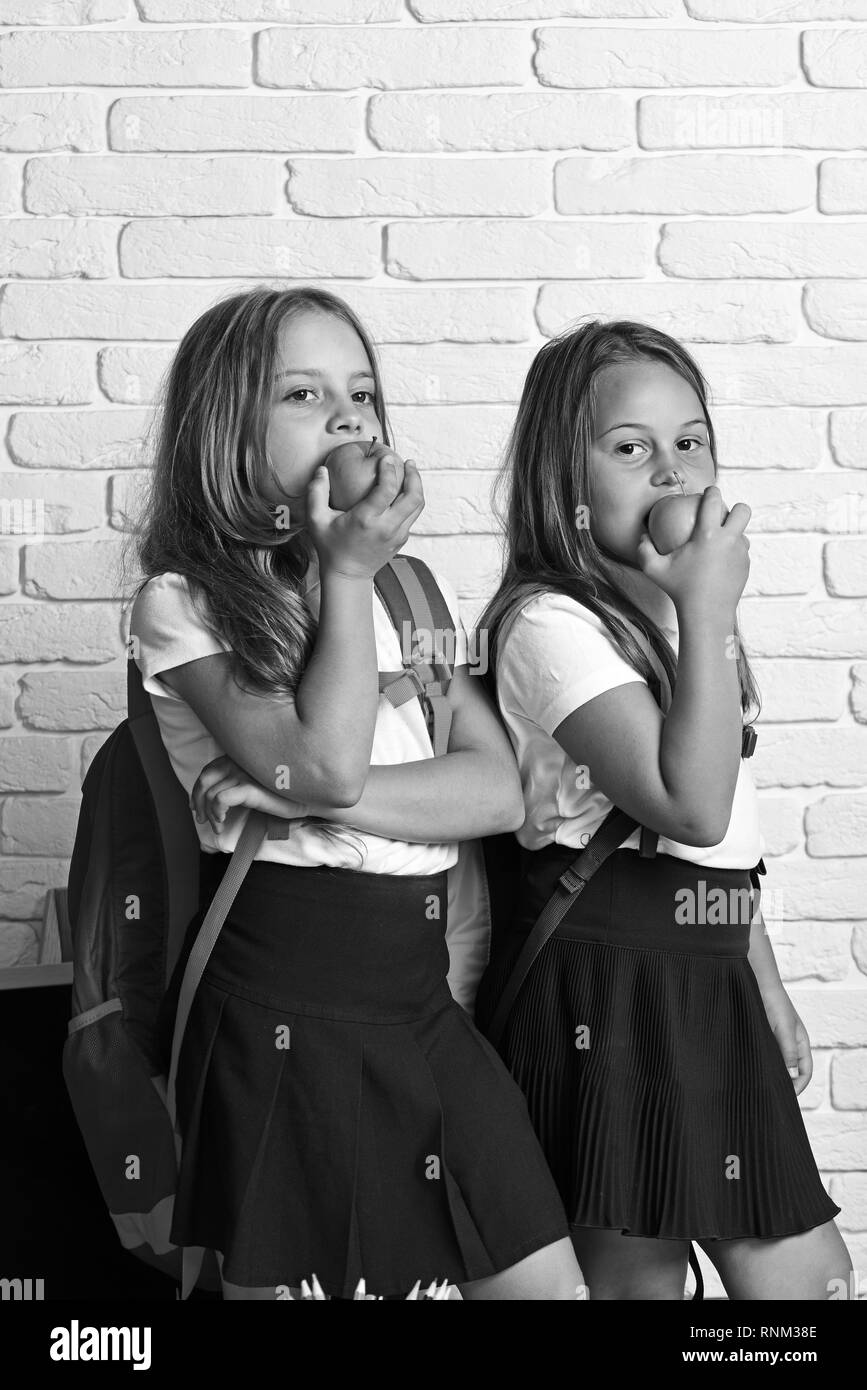 Back to school and happy time Cute children eating apples. Kids are ...