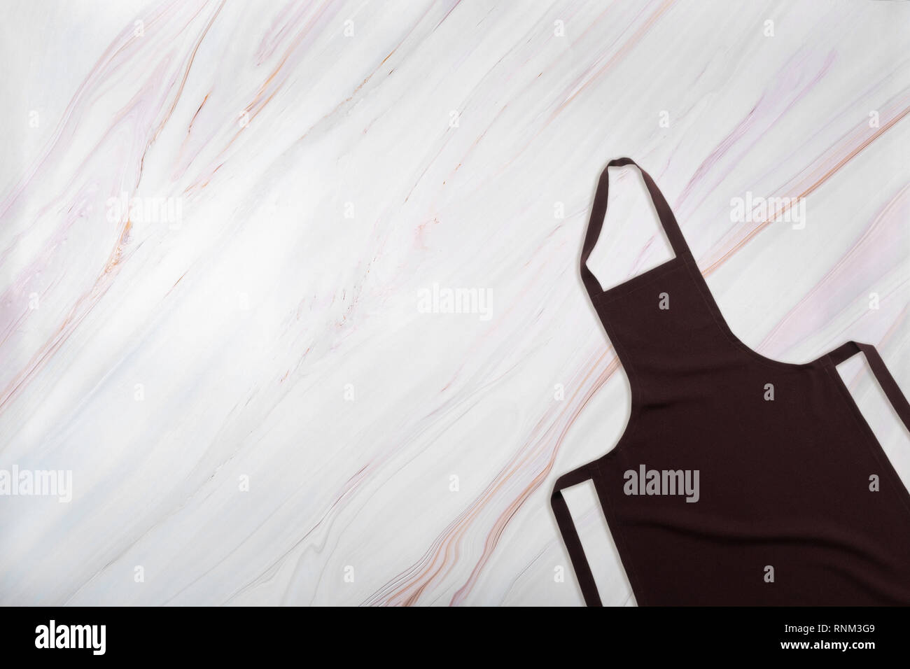 Brown apron on marble texture as background. Flat lay Stock Photo - Alamy