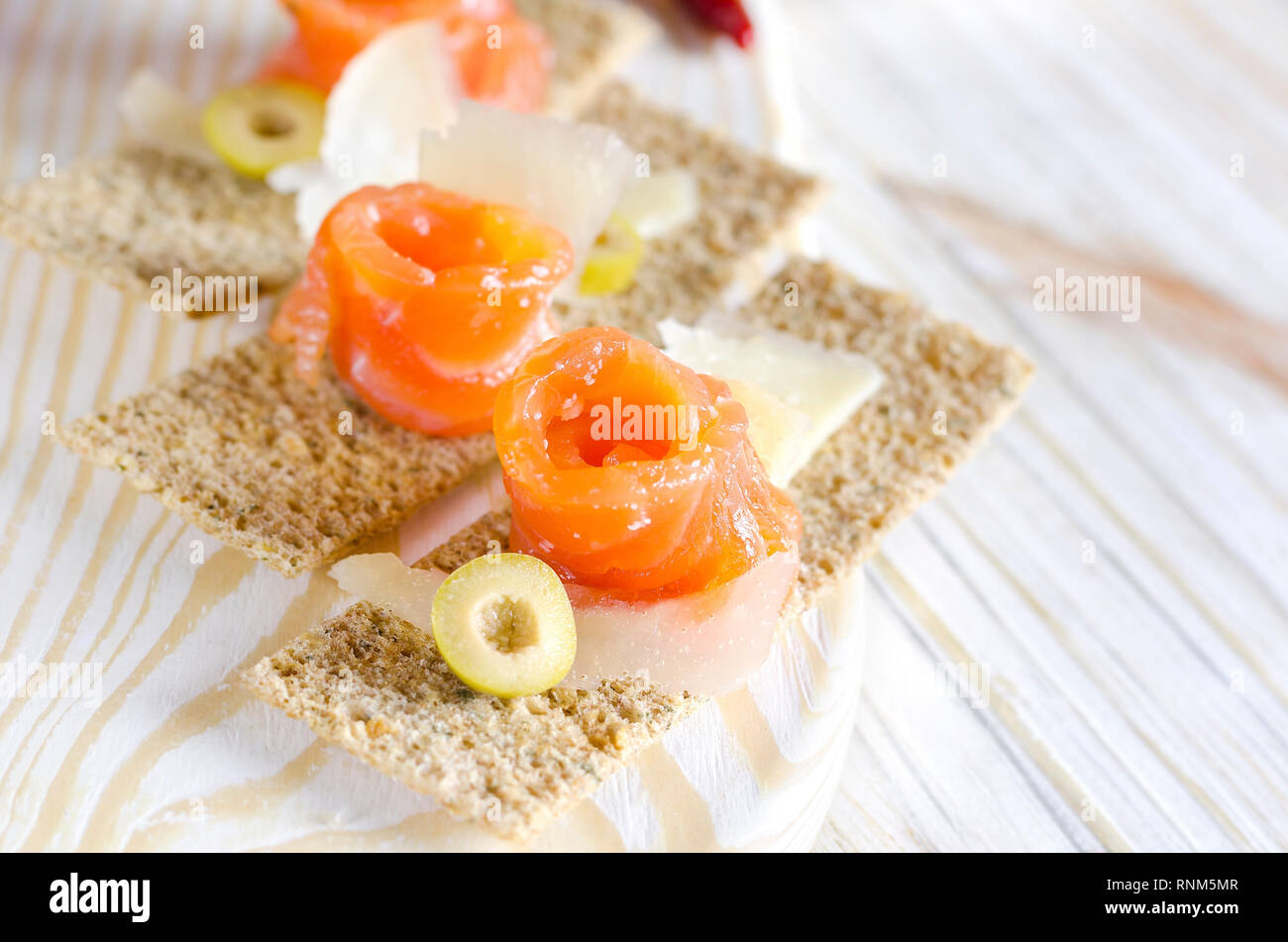 Delicious appetizer canapes with salmon, cheese and olive Stock Photo ...