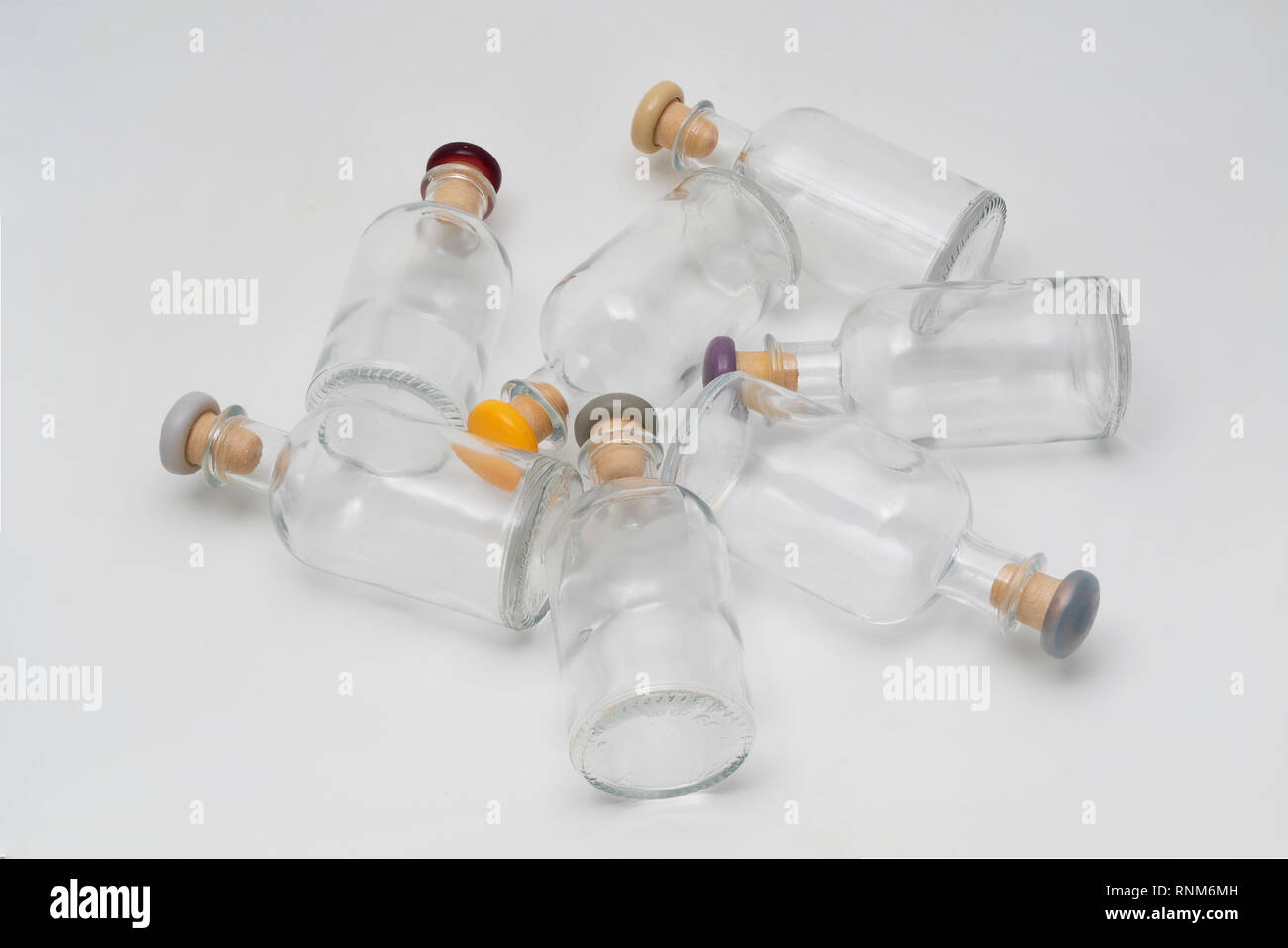 small glass bottles with colorful cap lying on the table Stock Photo ...