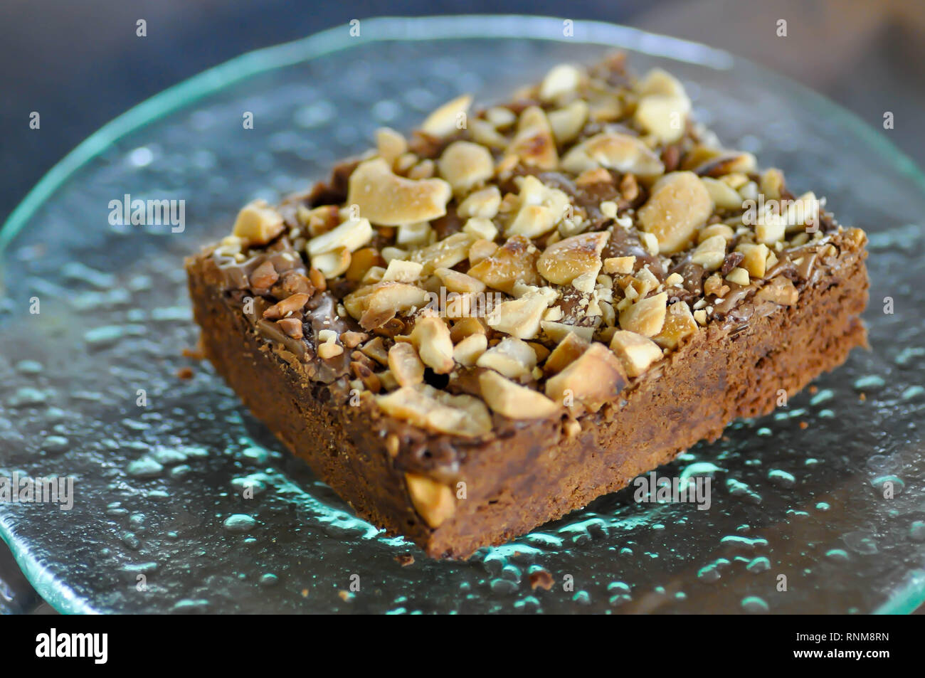 brownie or chocolate cake with nut topping Stock Photo - Alamy