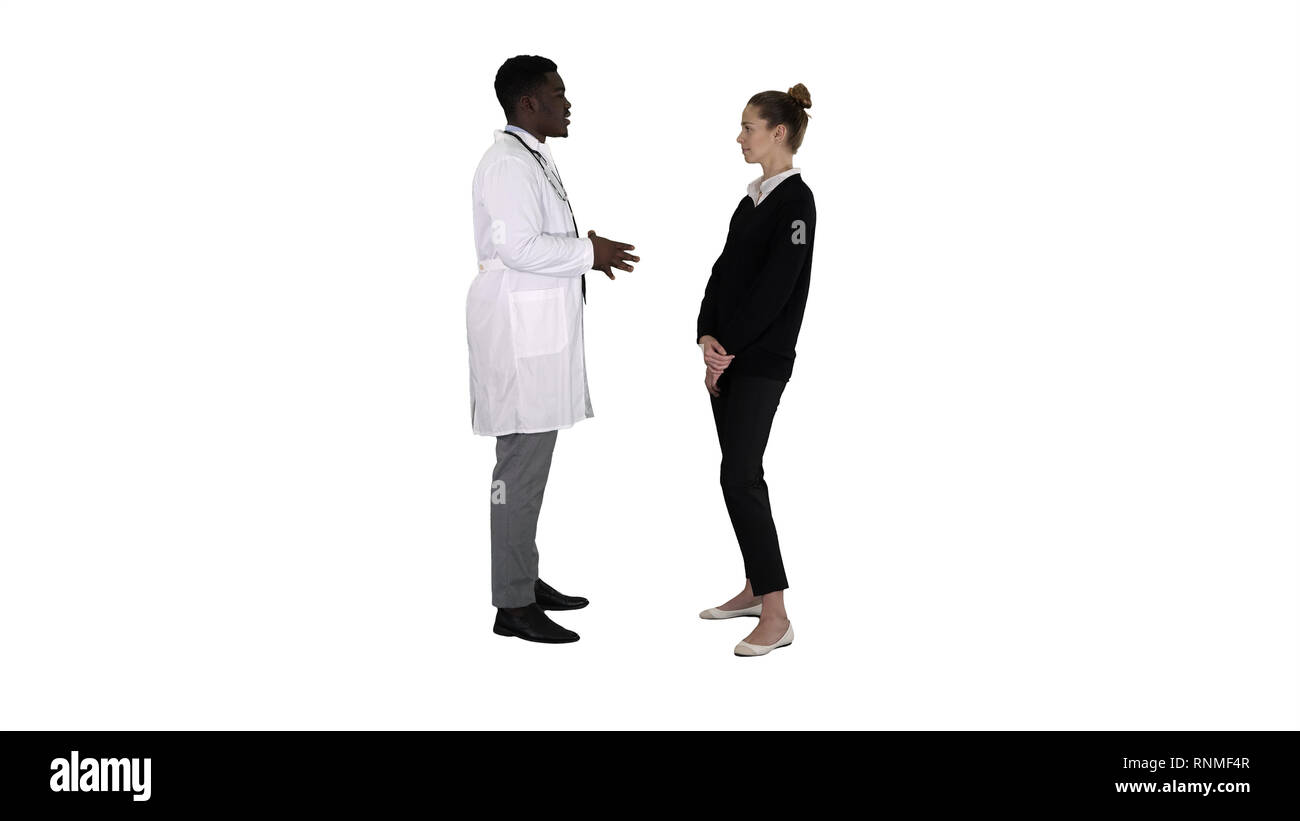 Male african doctor talking to female patient on white background Stock ...