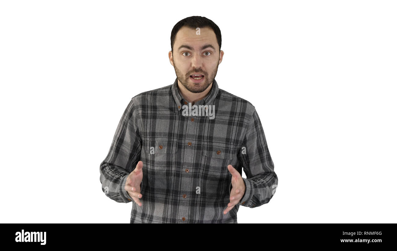 Man in casual walking and talking to the camera on white background ...