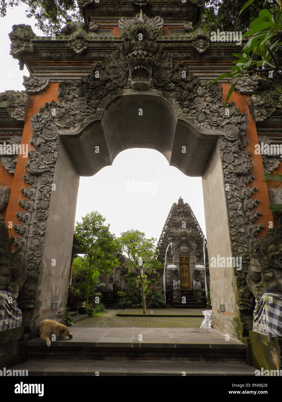Traditional carved entrance gate to Puri Kantor, a Hindu temple in Ubud ...