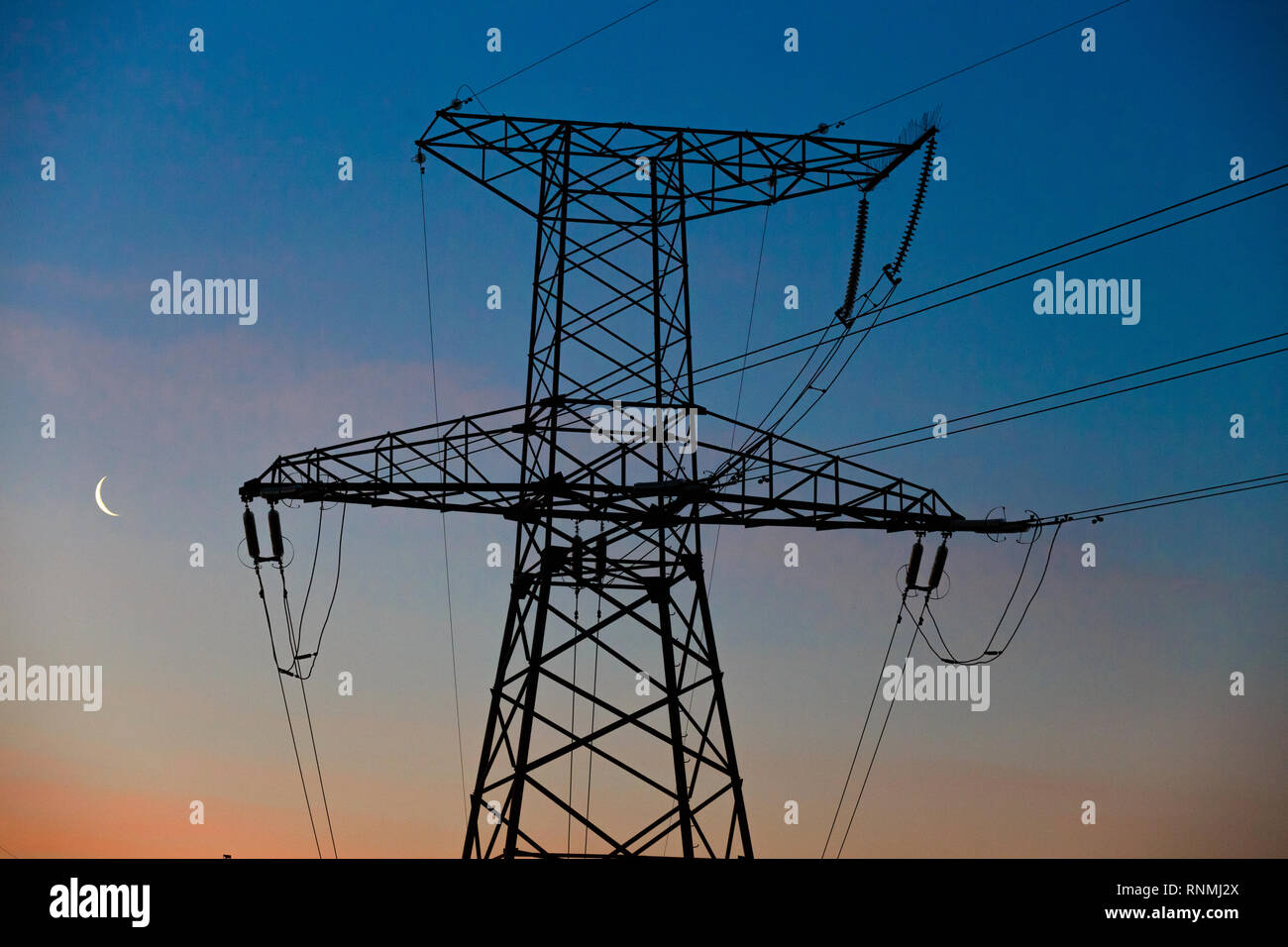 Electrical lines under a night sky with moon. power electric line and ...