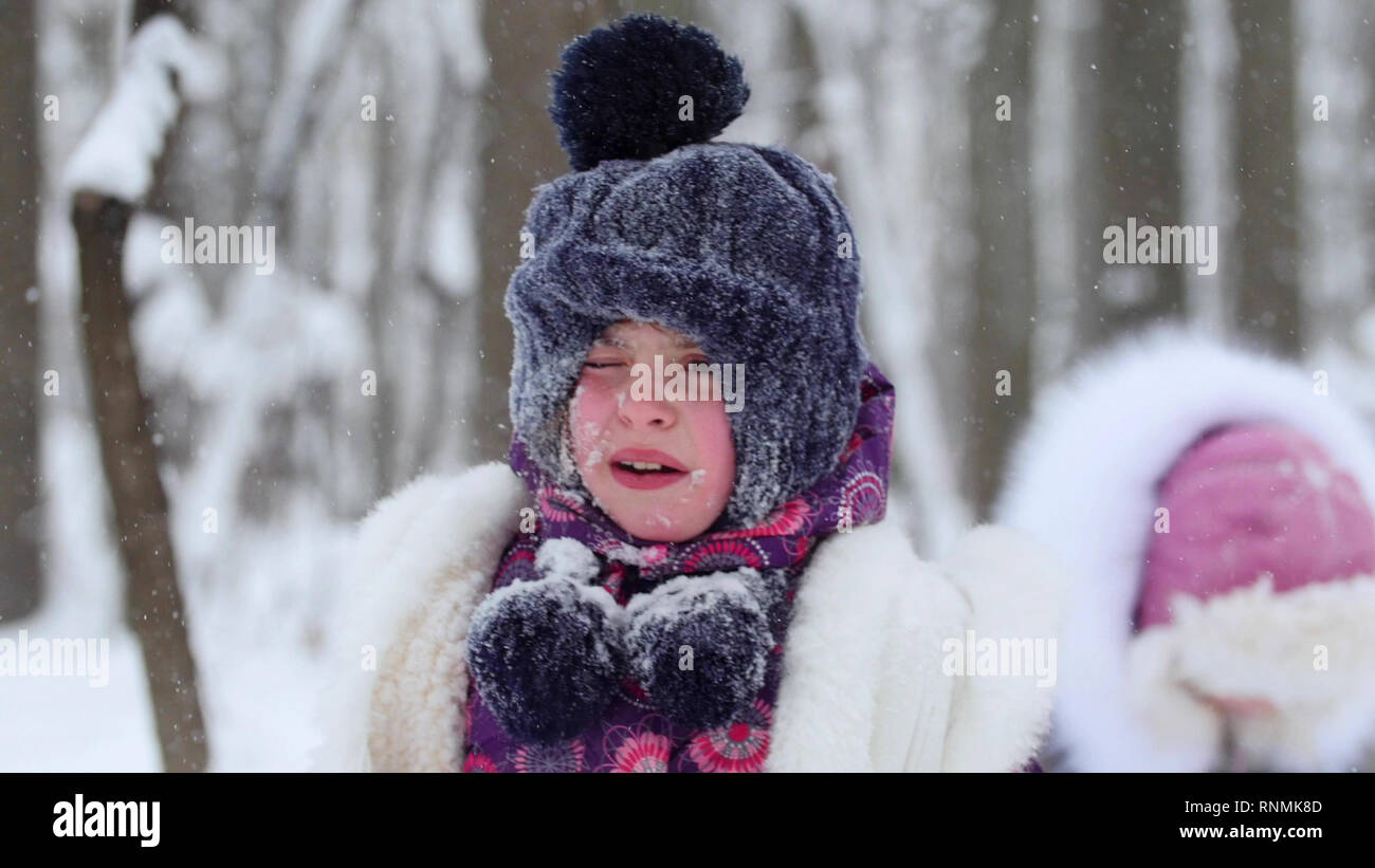 A little upset girl with snow on her face Stock Photo - Alamy