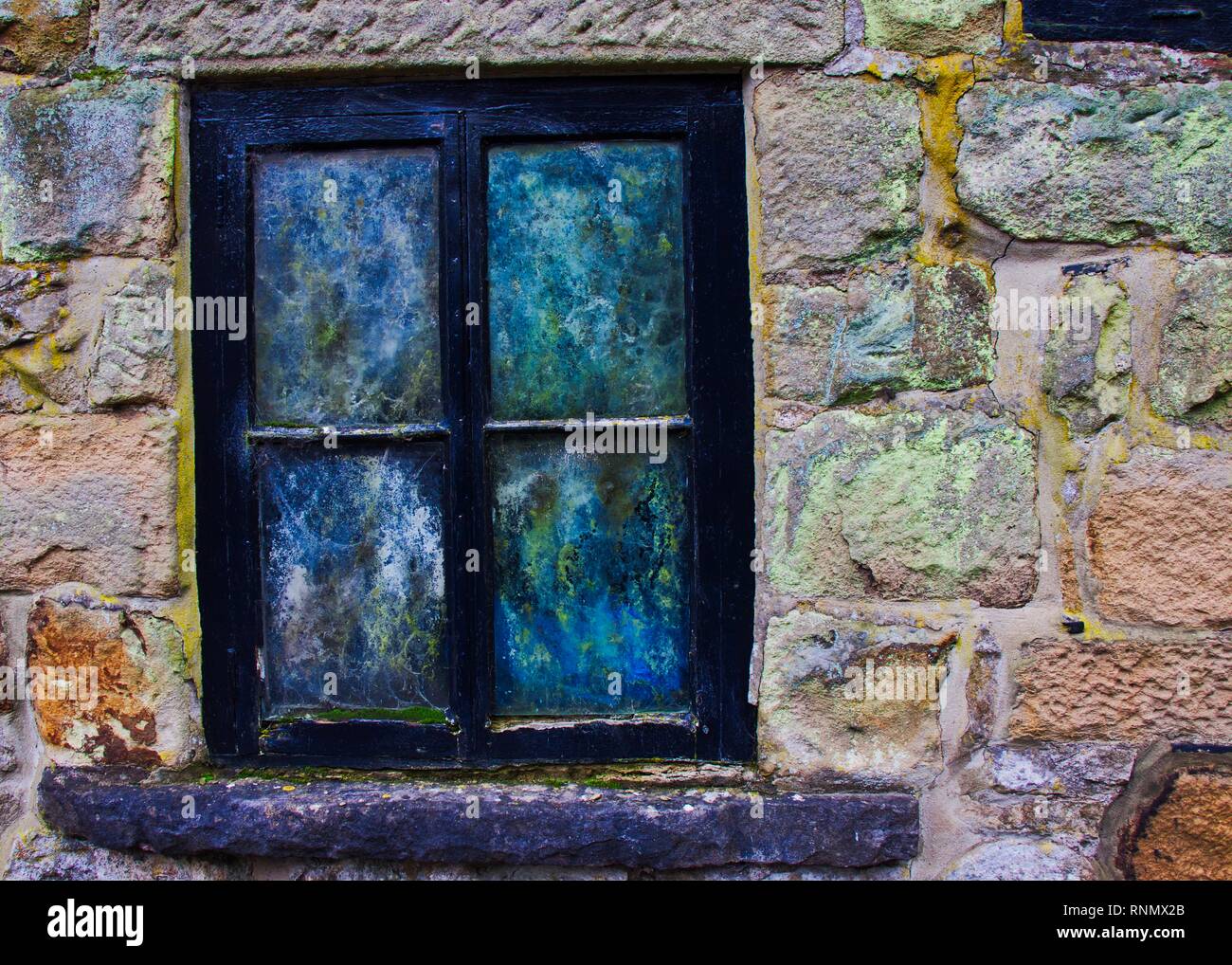 Colourful window in old cottage Stock Photo - Alamy