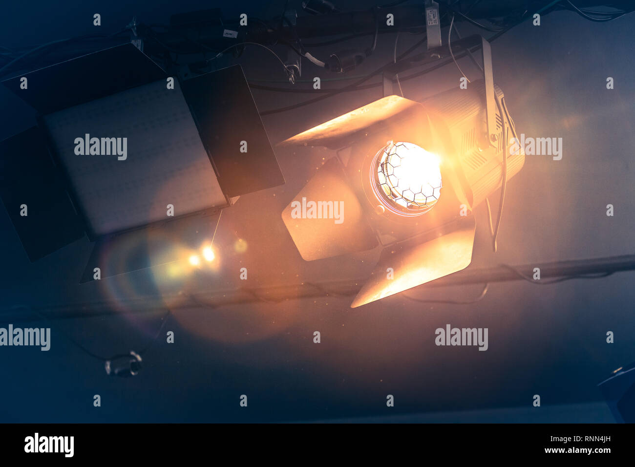 Professional orange studio spotlight hanging on the ceiling Stock Photo ...
