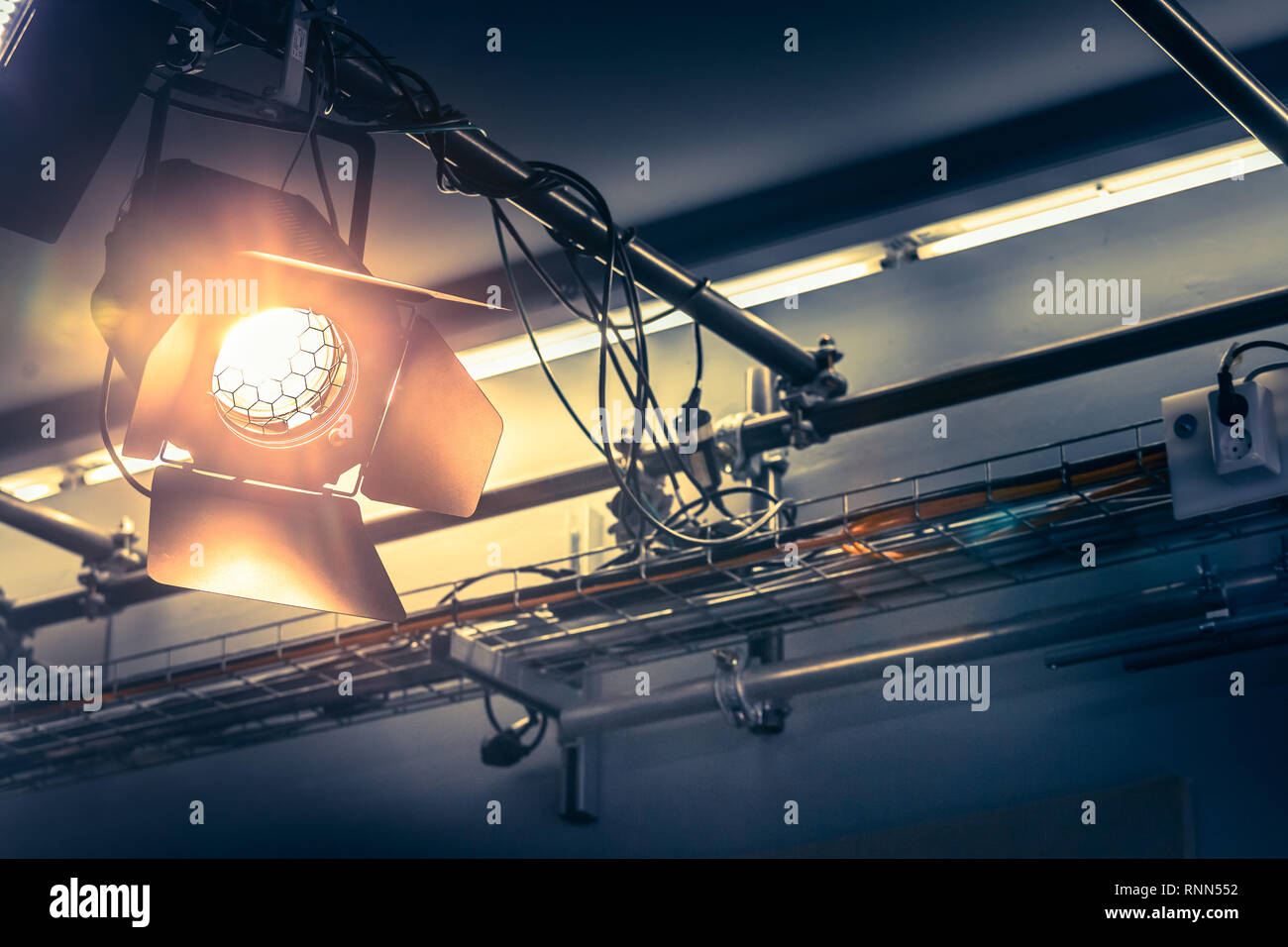 Professional orange studio spotlight hanging on the ceiling Stock Photo ...