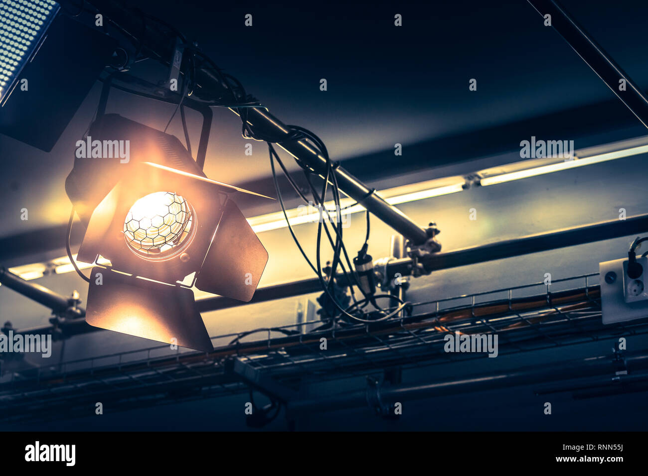 Professional orange studio spotlight hanging on the ceiling Stock Photo ...
