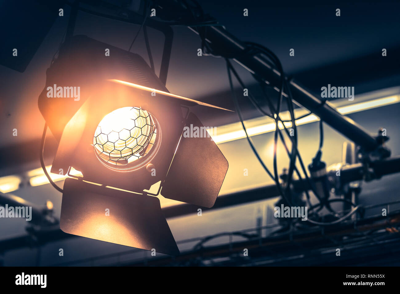 Professional orange studio spotlight hanging on the ceiling Stock Photo ...