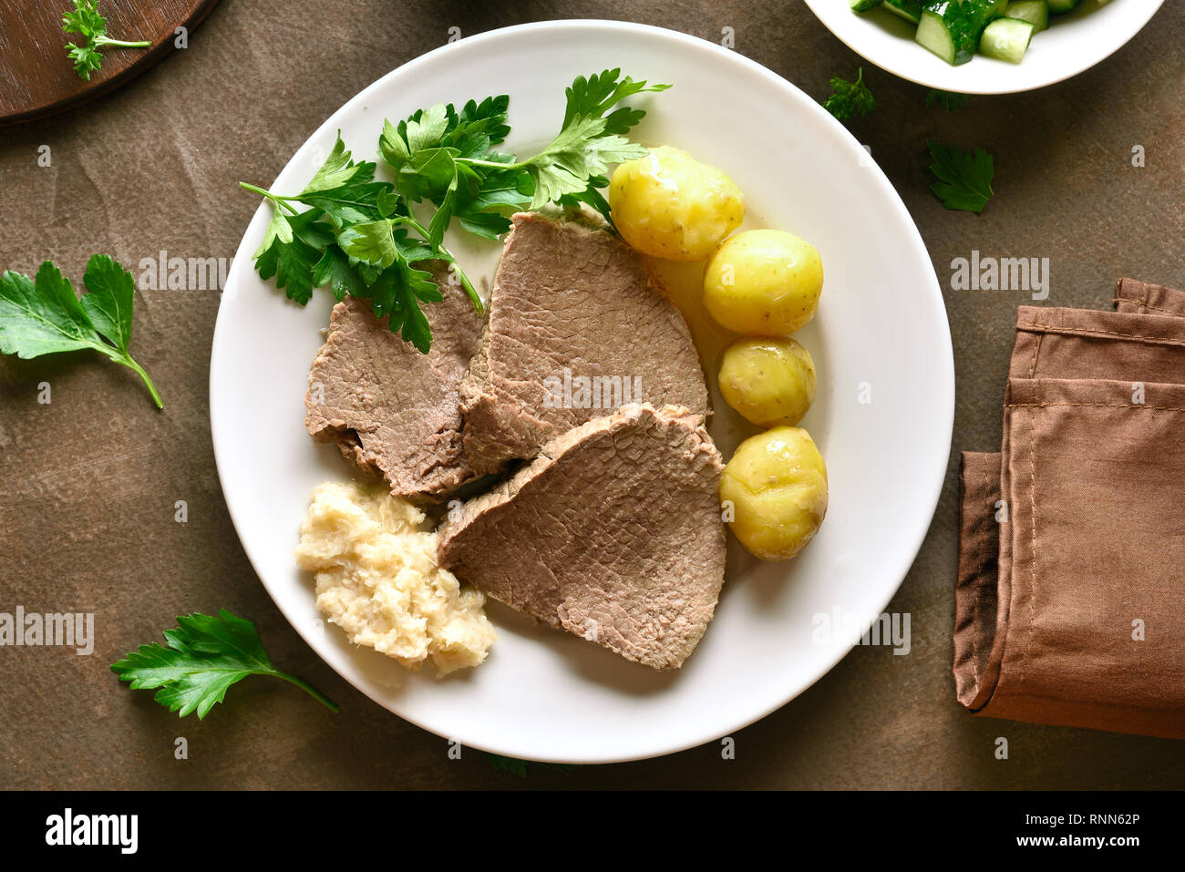 Tafelspitz, boiled beef with potatoes and horseradish on brown ...