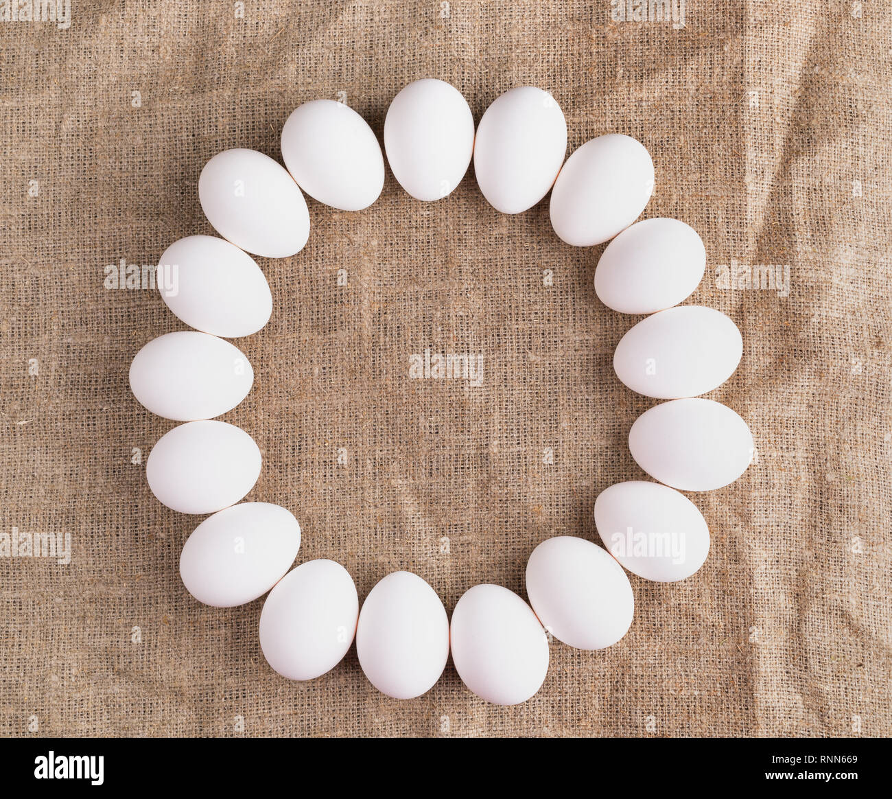 White chicken eggs lie in circle on rough canvas Stock Photo - Alamy