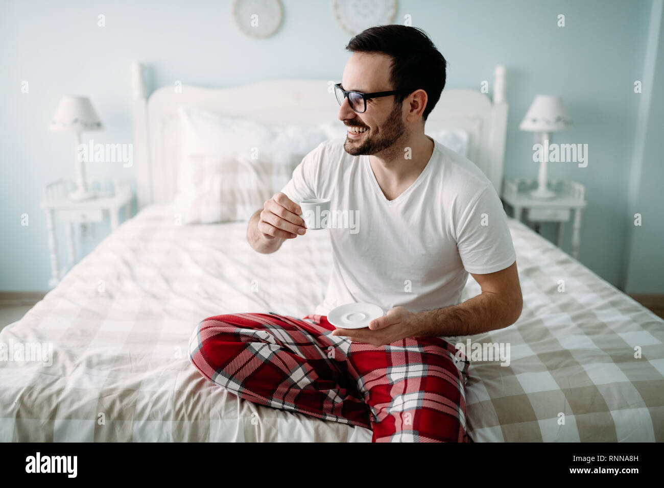 Portrait of handsome young man drinking coffee Stock Photo - Alamy