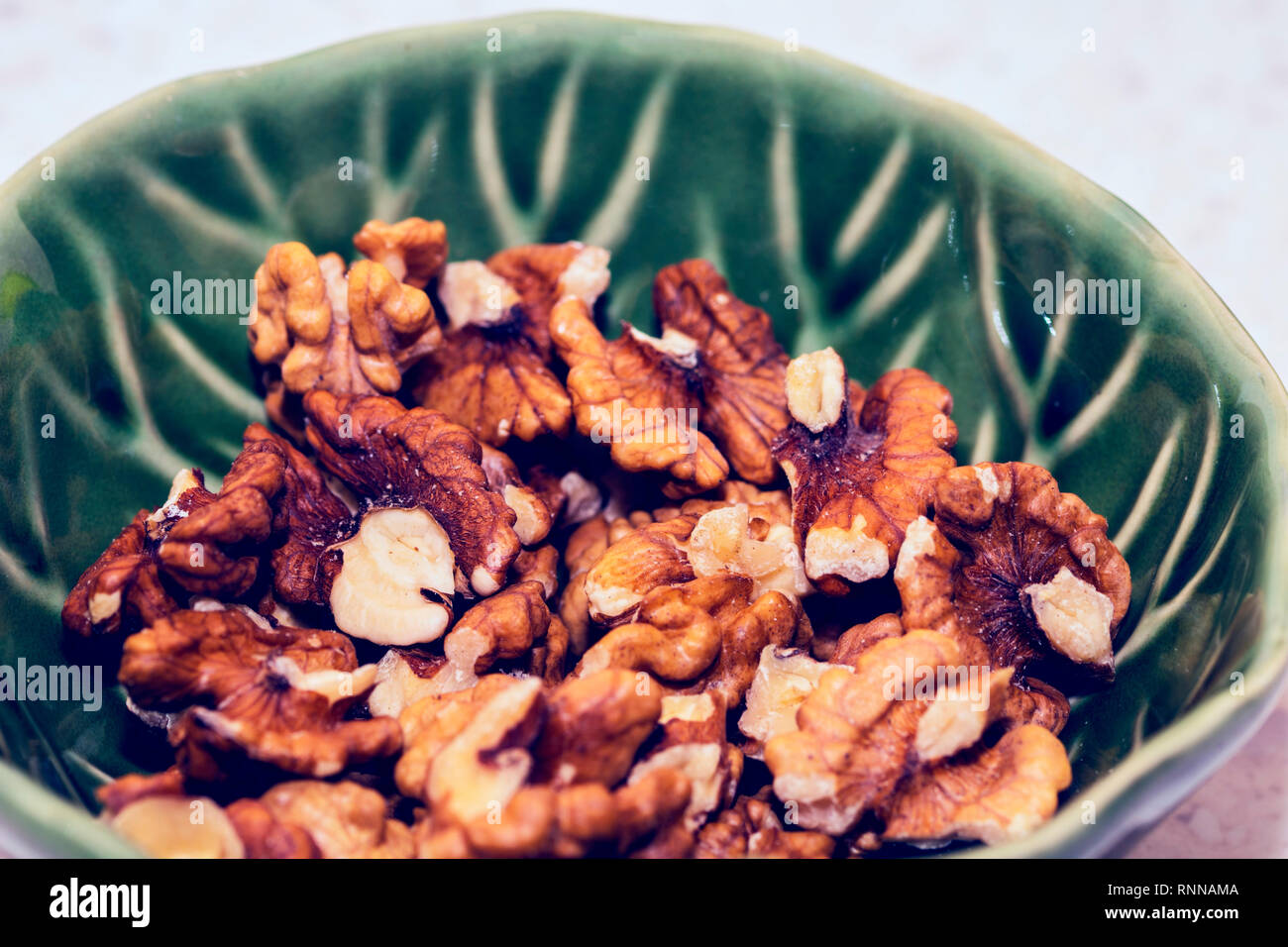 Green textured bowl full of shelled pecans Stock Photo - Alamy