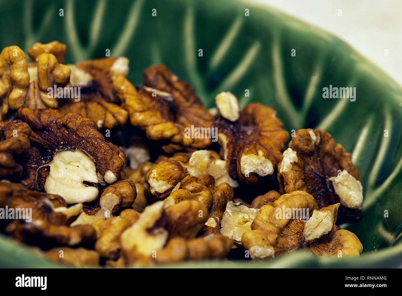 Green textured bowl full of shelled pecans Stock Photo - Alamy