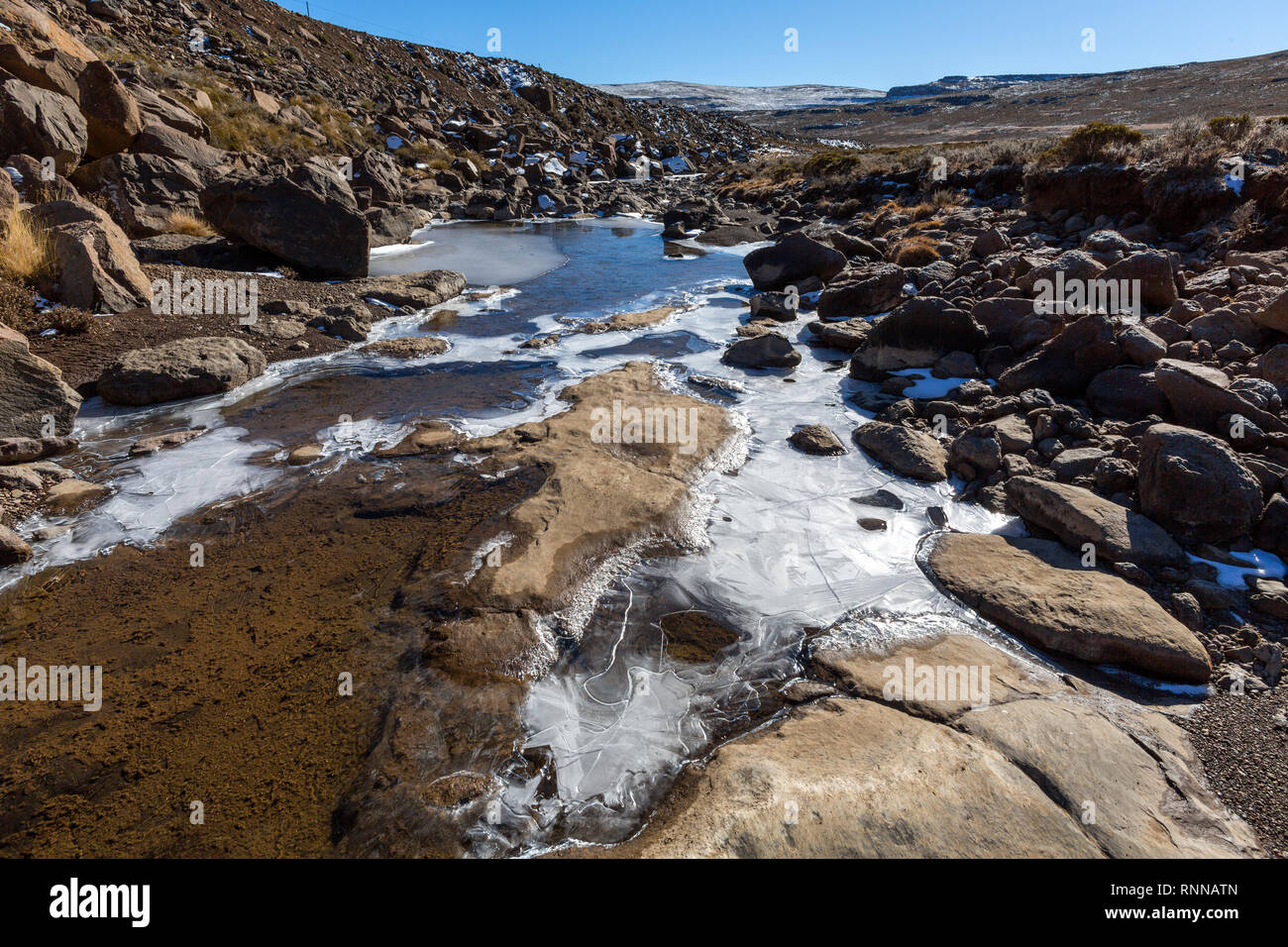 Frozen water between the rocks Stock Photo - Alamy