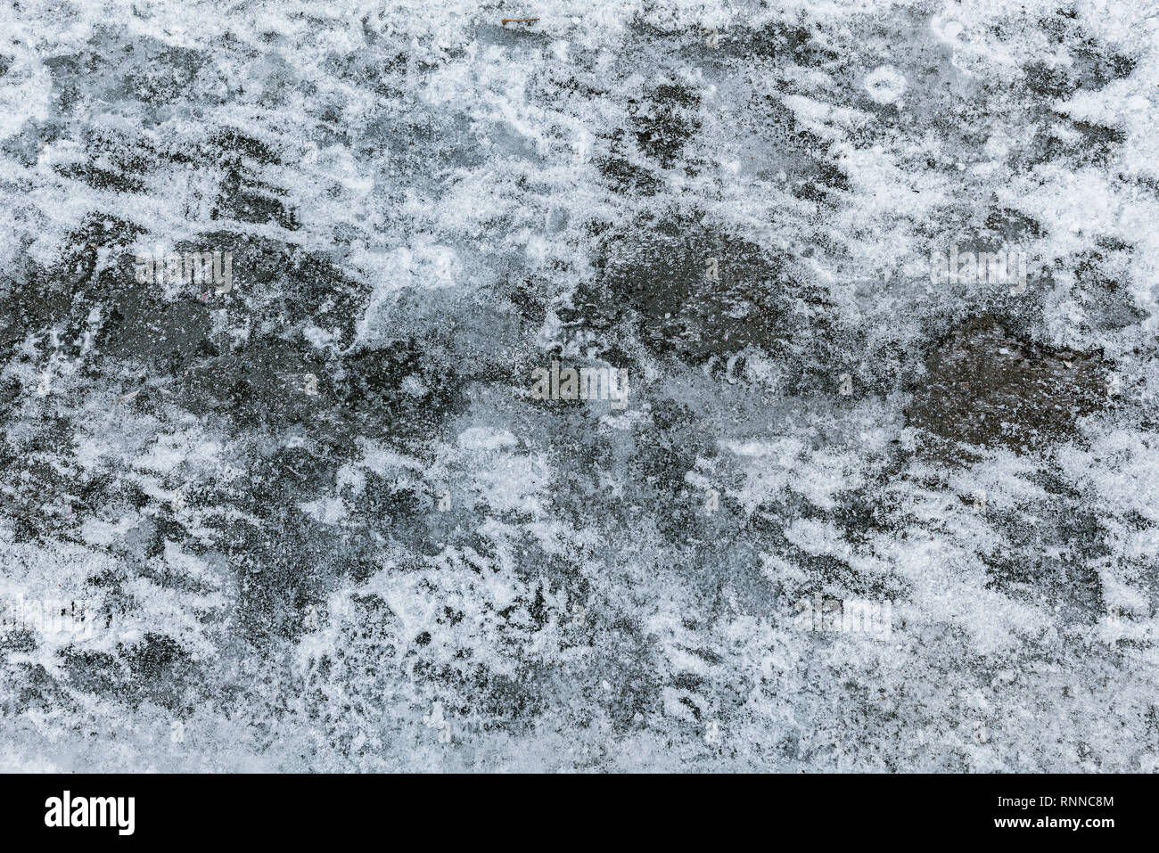 Background texture of rough asphalt with melting snow and ice Stock ...