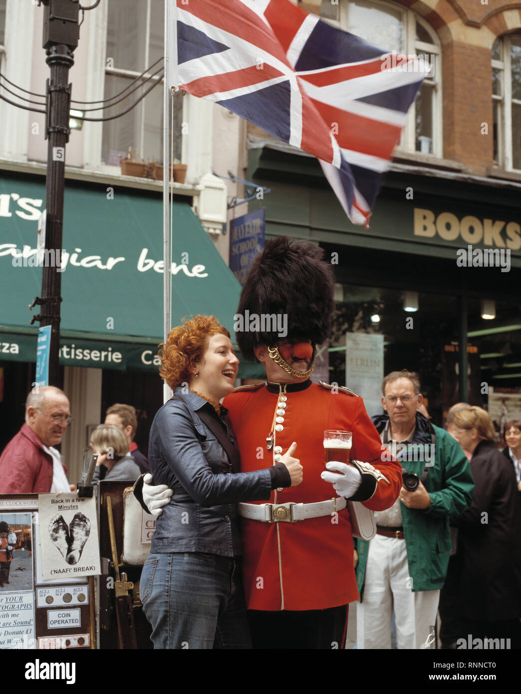 UK. England. Man dressed as a Coldstream Guard holding pint of beer and ...