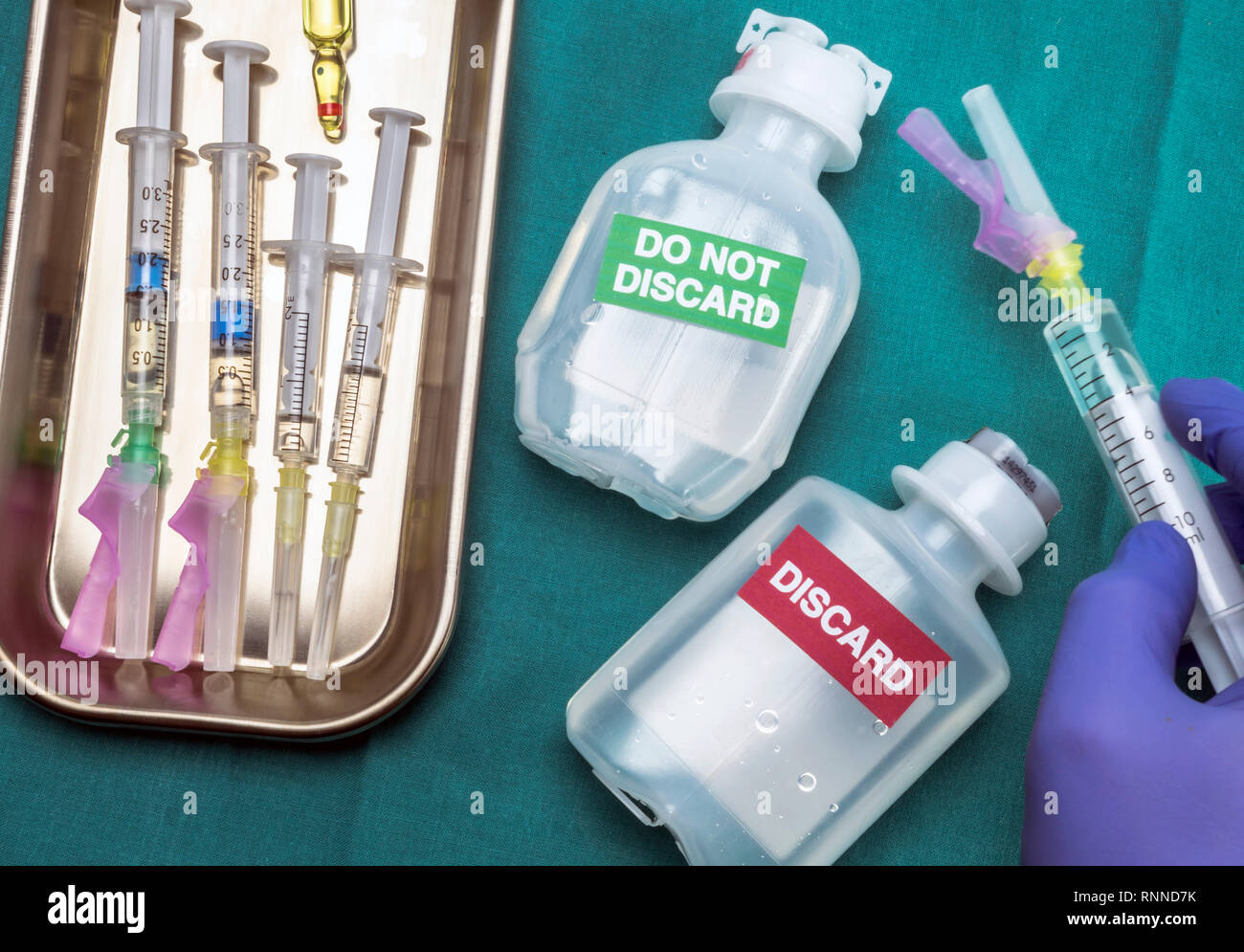Nurse preparing parenteral medication discard and not discard, syringes ...