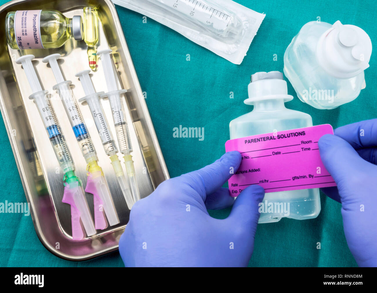 Nurse preparing hospital medication, solution sticker parenteral ...