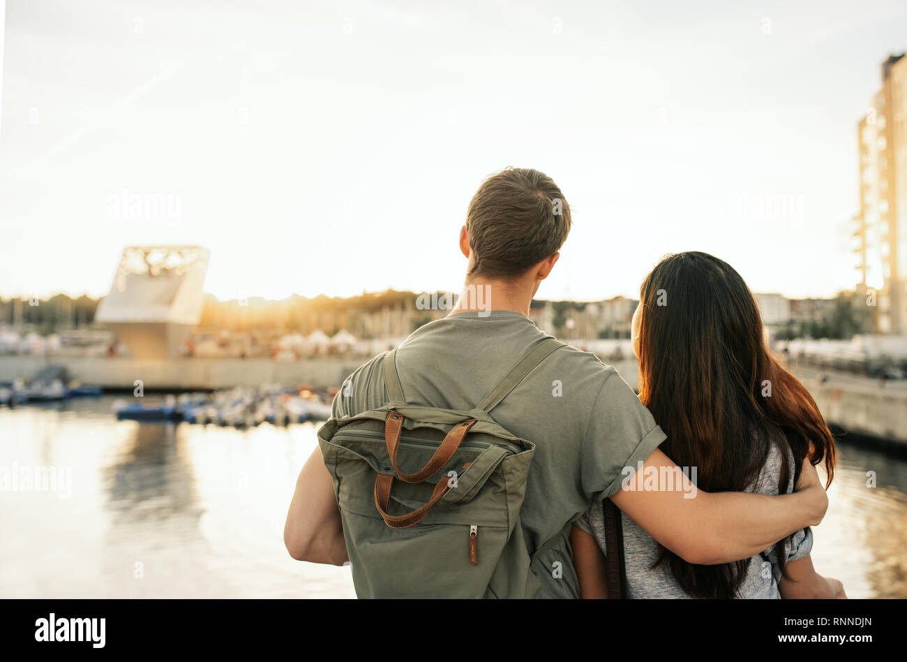 Couple standing arm in arm hi-res stock photography and images - Alamy