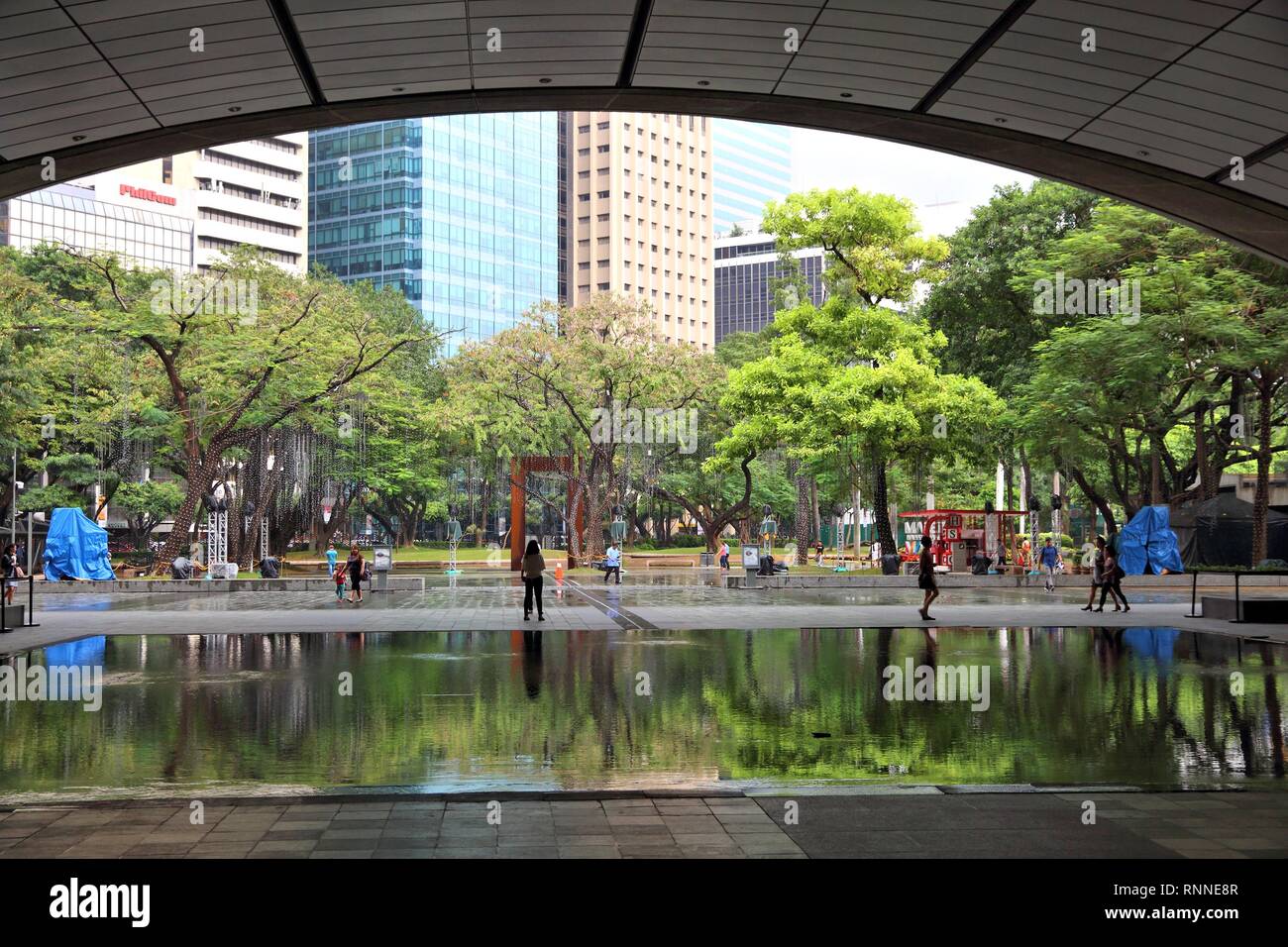 MANILA, PHILIPPINES - DECEMBER 7, 2017: People visit Ayala Triangle in ...
