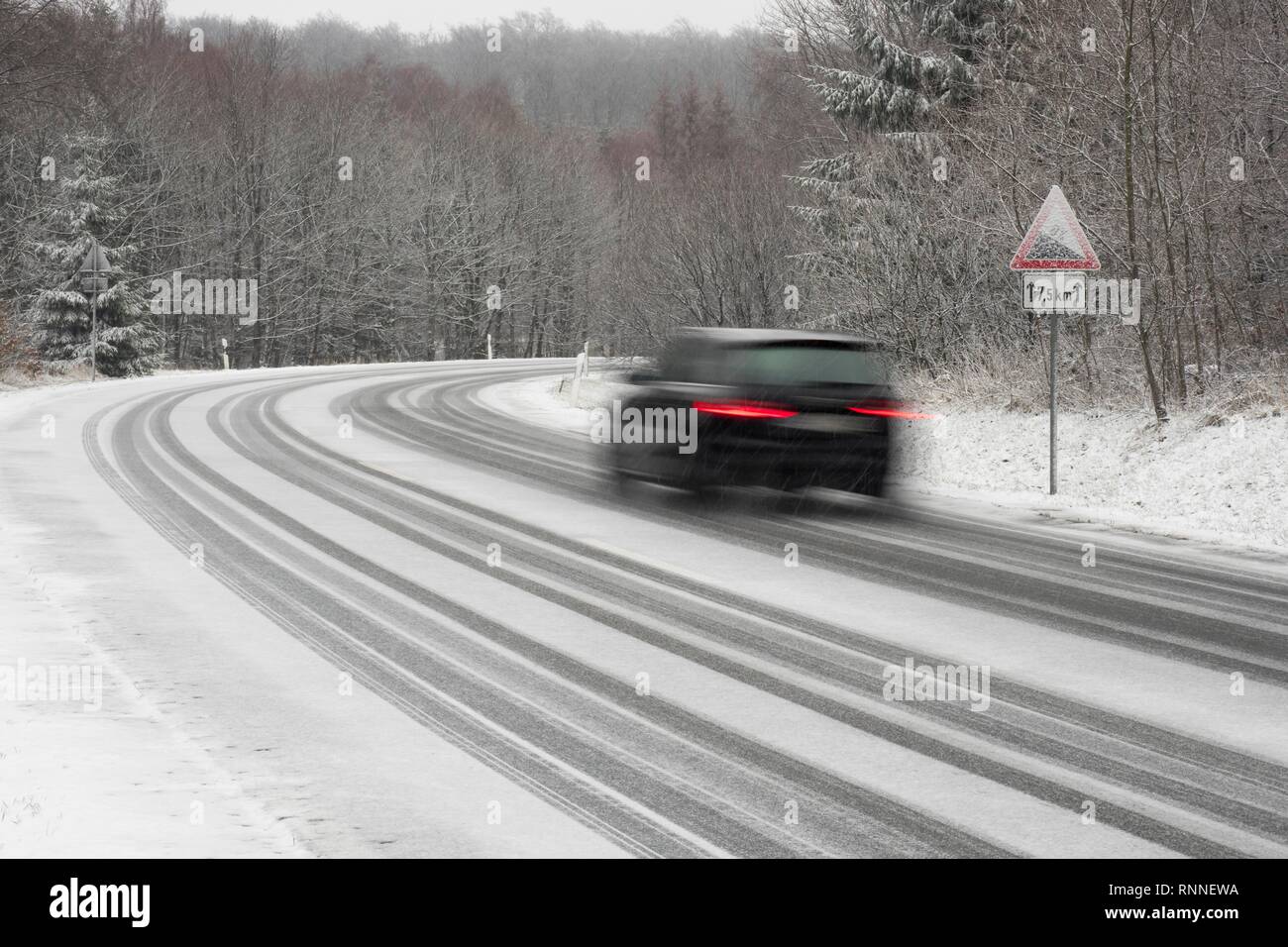 Car driving on snow-covered road, Warning sign, gradient, Hesse ...