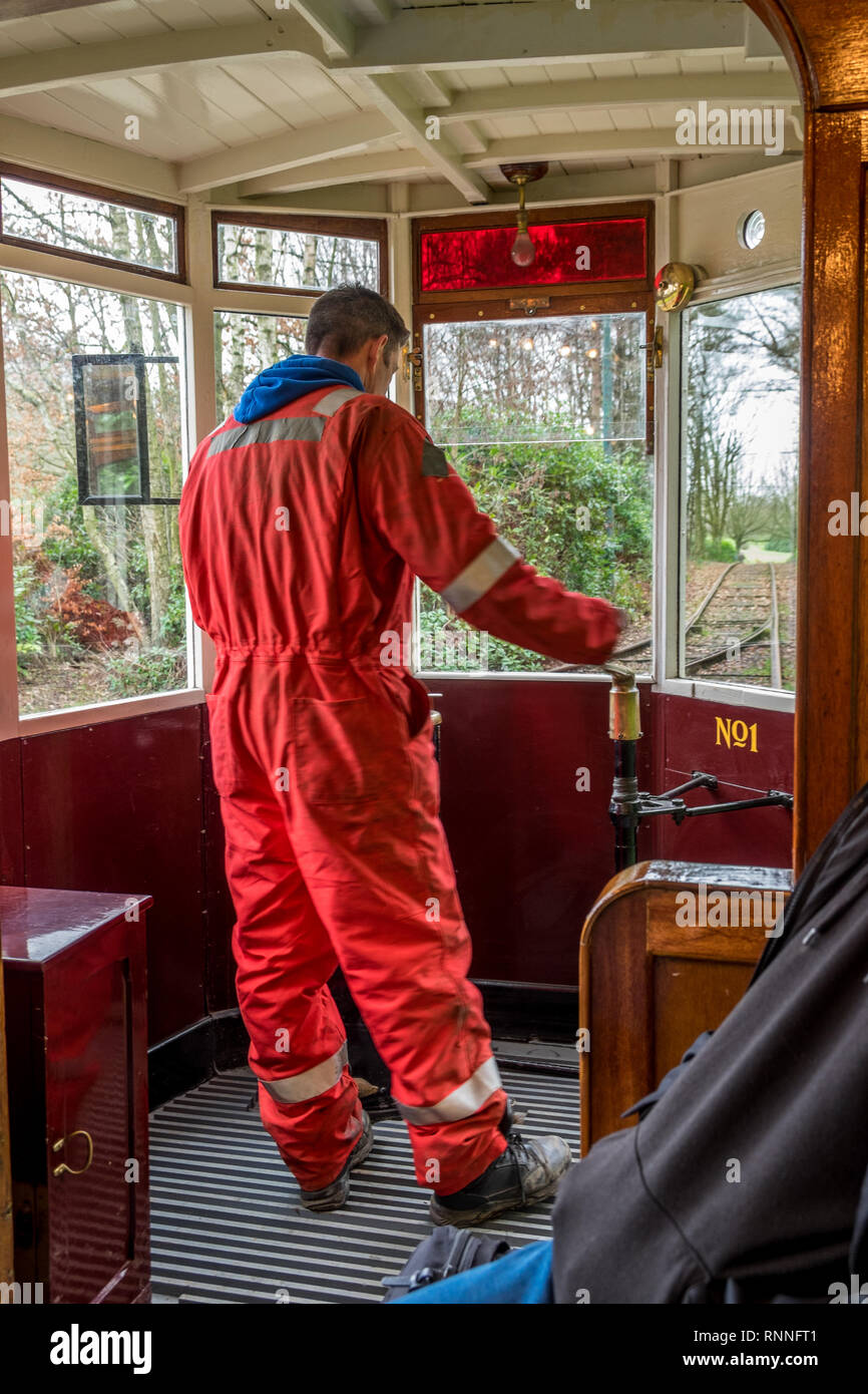Engineer driving the heritage tram using the brake lever to control the ...