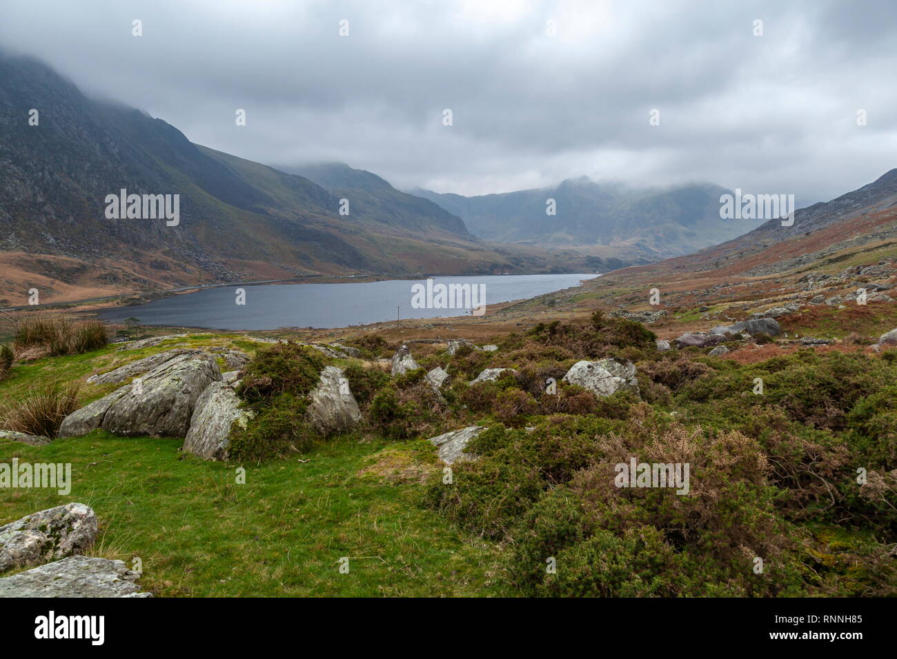 The Ogwen valley and Llyn Ogwen, with low cloud cover over the peaks of ...