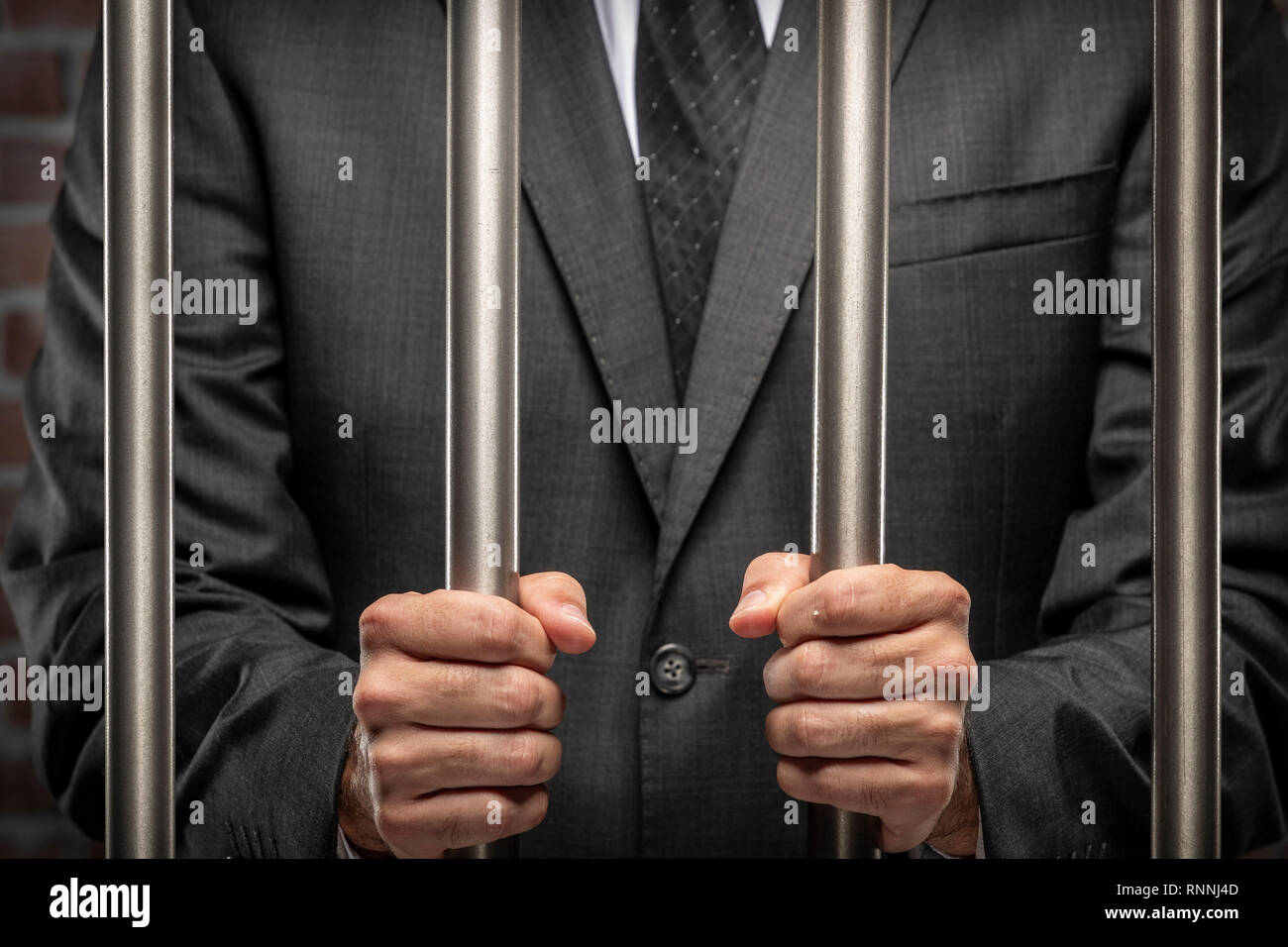 Brazilian man holding bills of money with a handcuff in a jail. concept ...