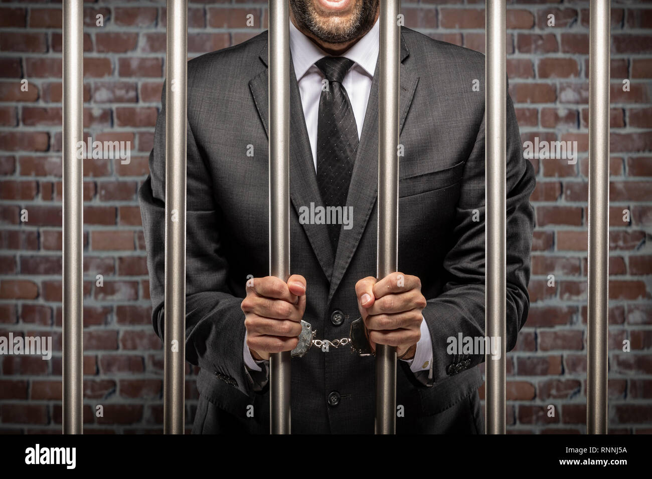 Brazilian man holding bills of money with a handcuff in a jail. concept ...