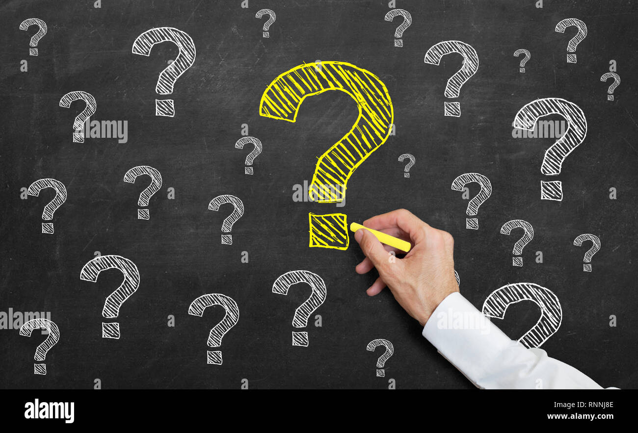 teacher drawing a yelow question mark on blackboard Stock Photo - Alamy