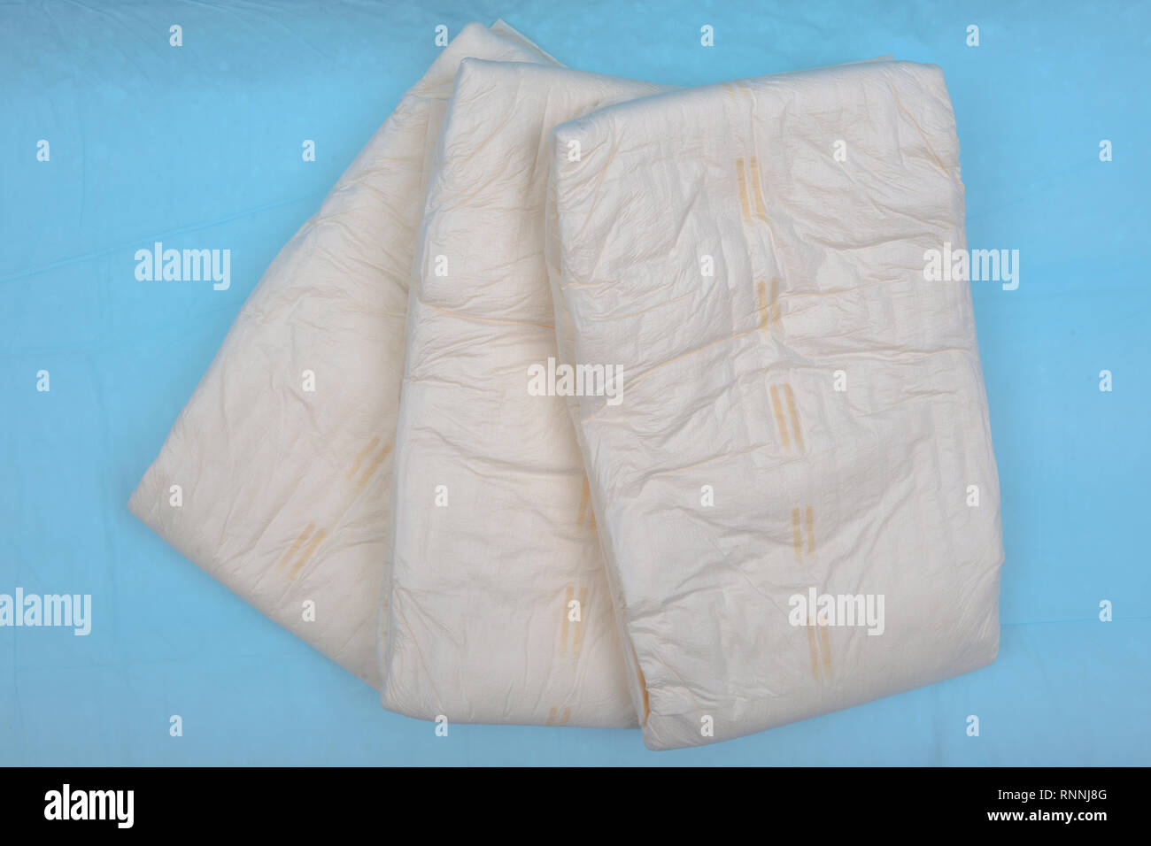 Extra Large Size Briefs For Adults Isolated On Blue Under Pad Diapers