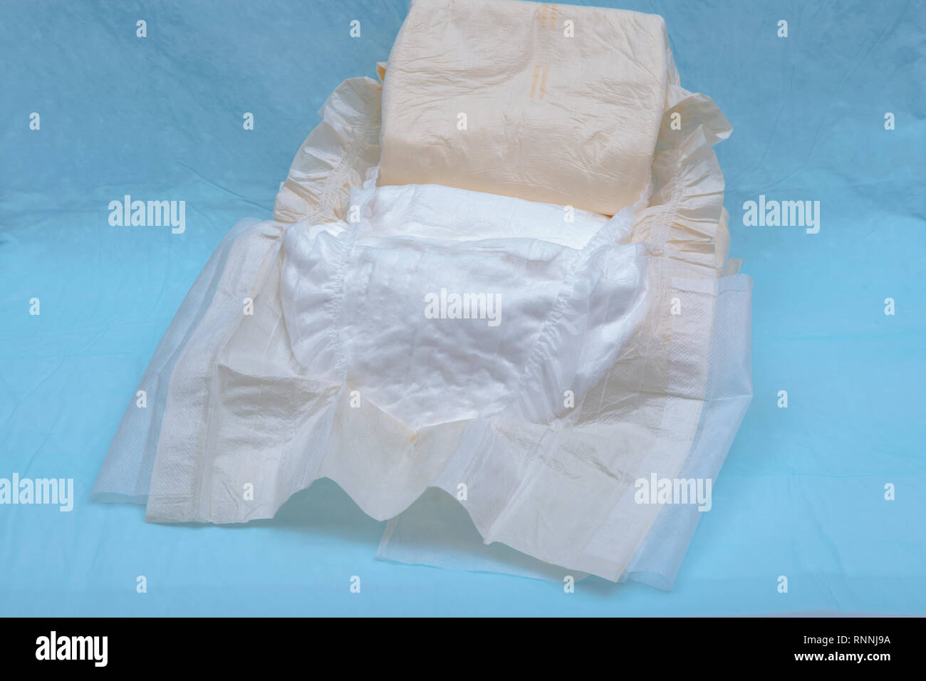 Extra large size briefs for adults isolated on blue under pad. Diapers ...