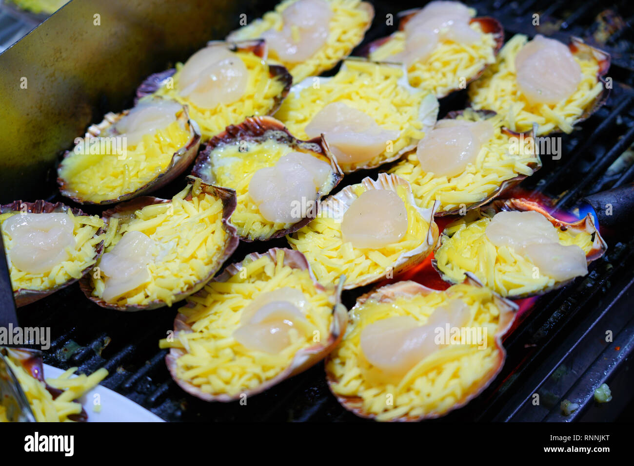 Broiled scallops with cheese on the shell at a fish market in Sydney ...