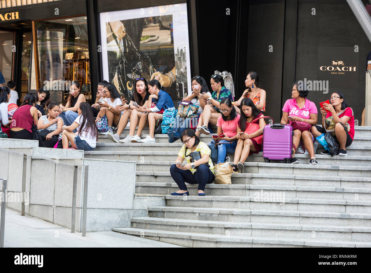 Shoppers Resting outside ION Mall, Singapore, Orchard Road Street Scene ...