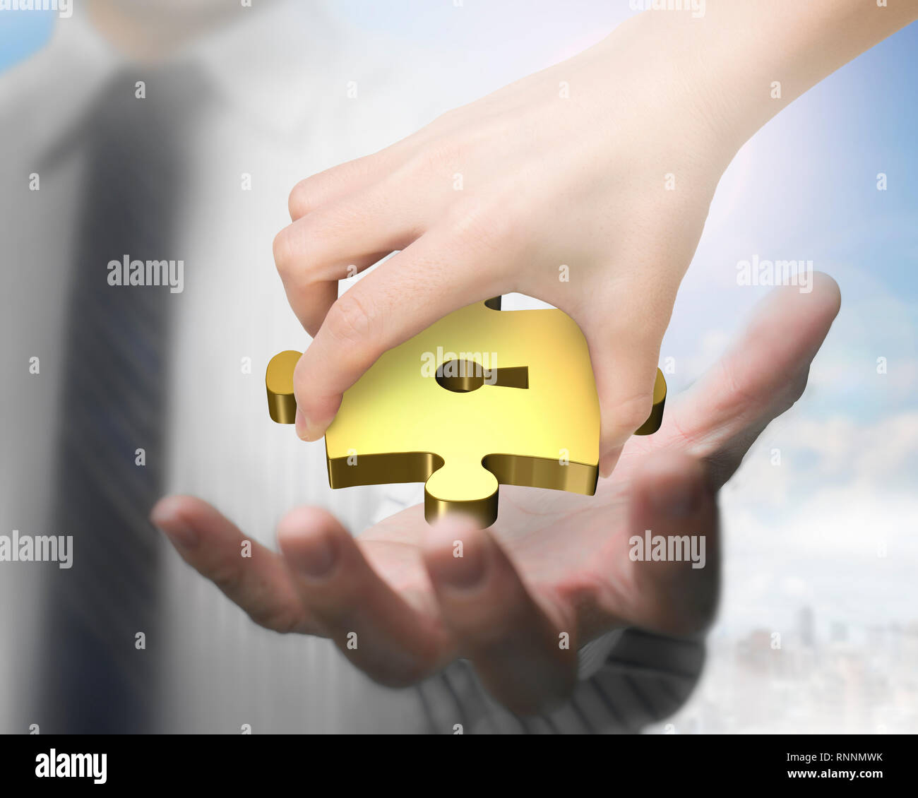 Woman's hand giving one golden puzzle piece with keyhole to man's hand ...