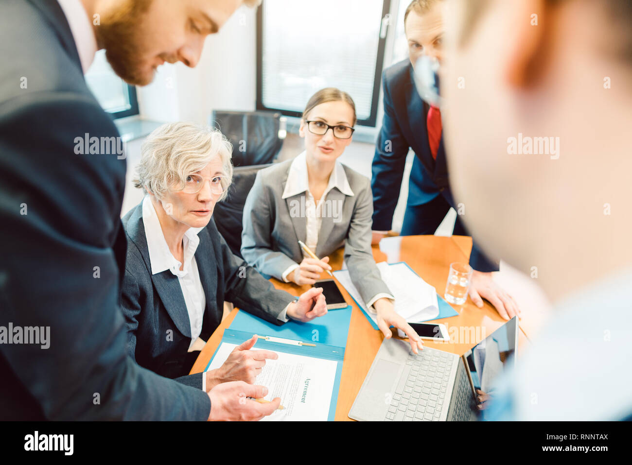 Team of motivated business people driving a project forward Stock Photo ...