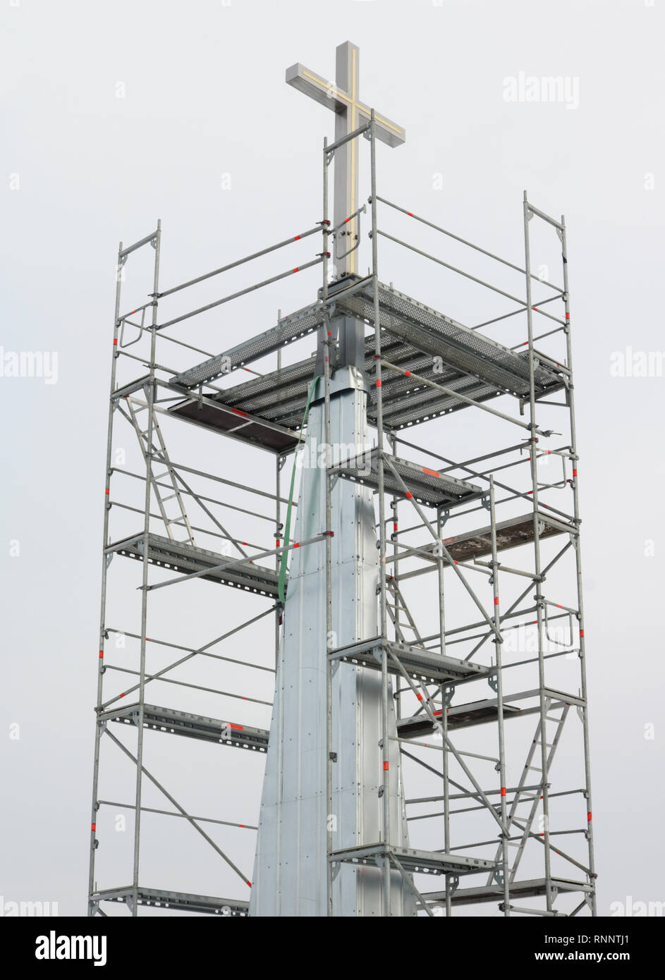 Installation of a new cross on a Catholic church. Cloudy winter day ...
