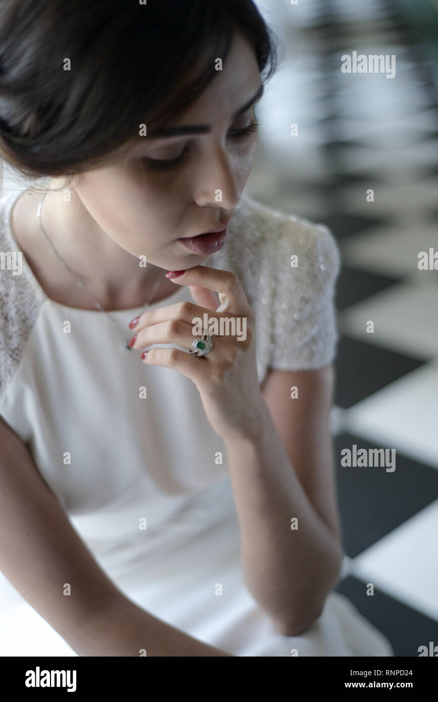 A young pensive couple have a traditional English White Wedding, they ...