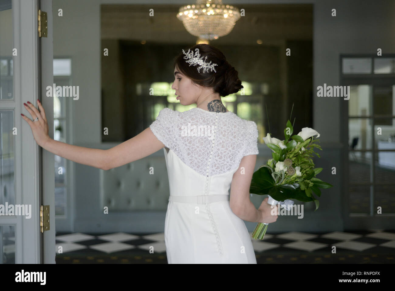 A young pensive couple have a traditional English White Wedding, they ...