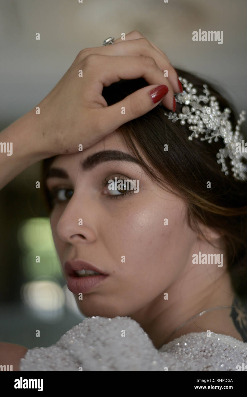 A young pensive couple have a traditional English White Wedding, they ...
