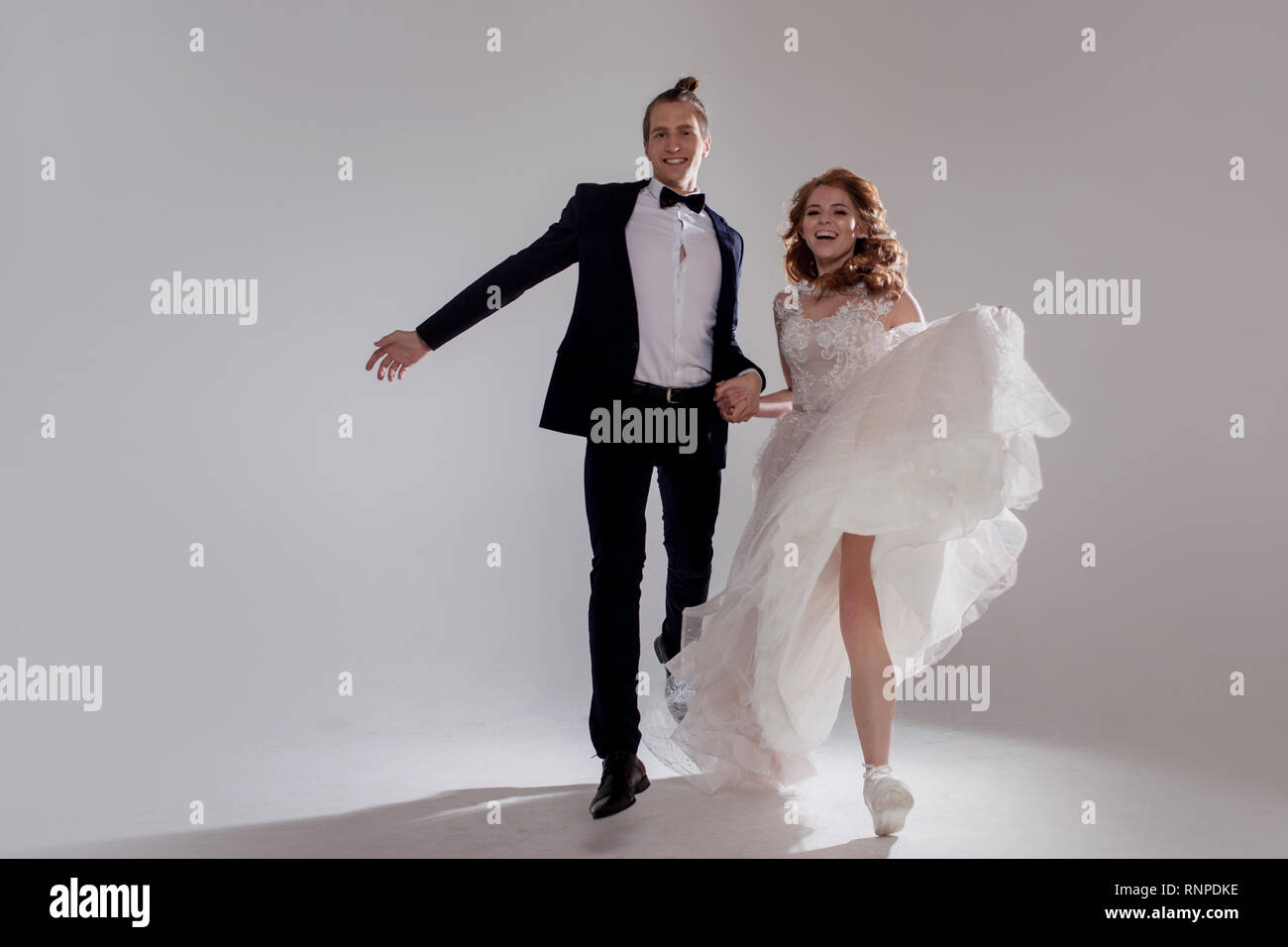 Happy young couple laughing and dancing together. The couple in the ...