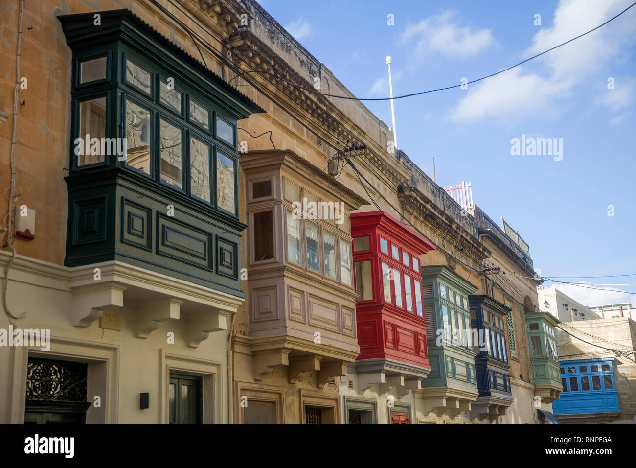 Facade with traditional colorful balcony and shutters in Mdina, Malta ...