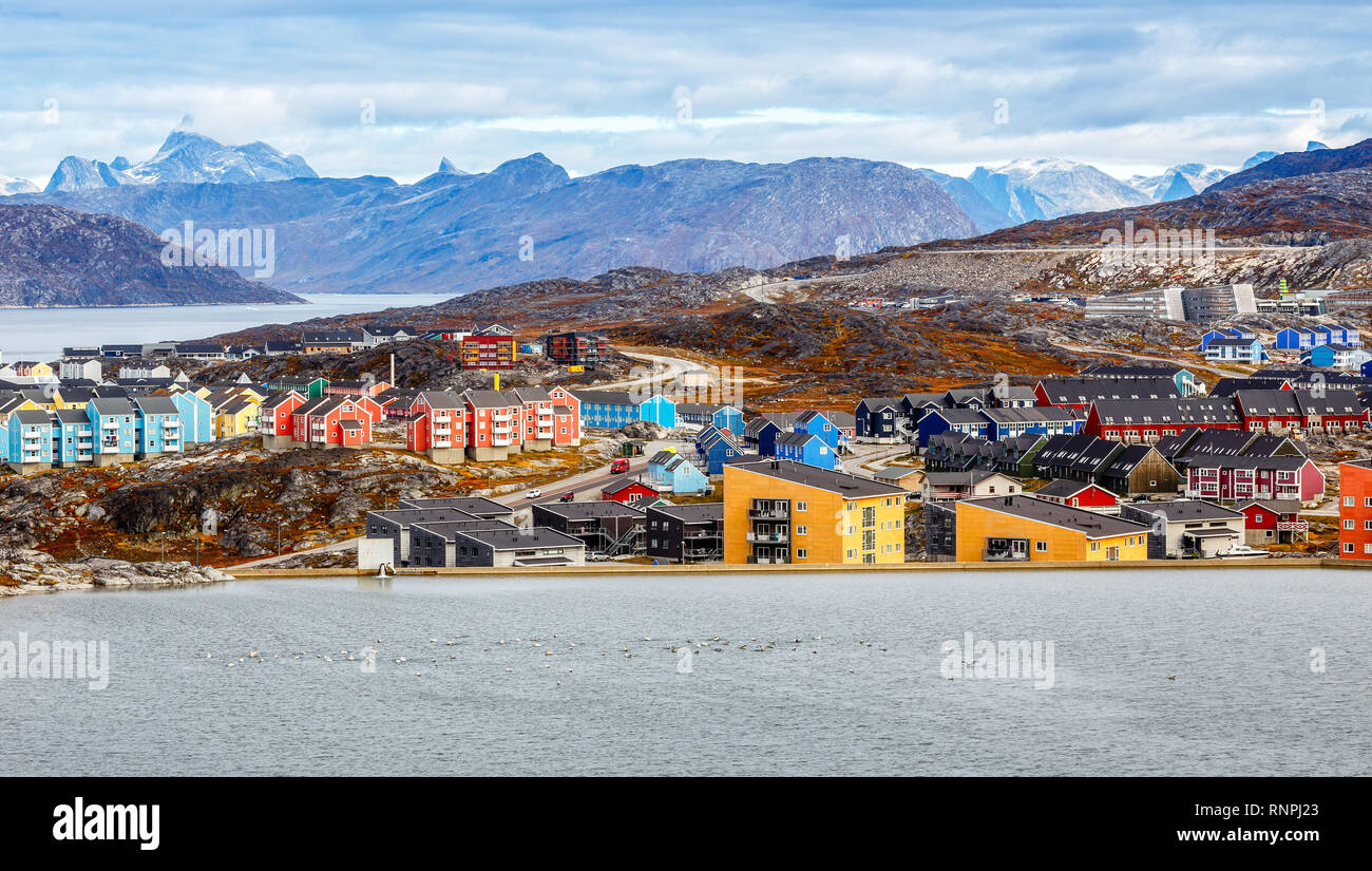Colorful Inuit buildings in residential district of Nuuk city with lake ...