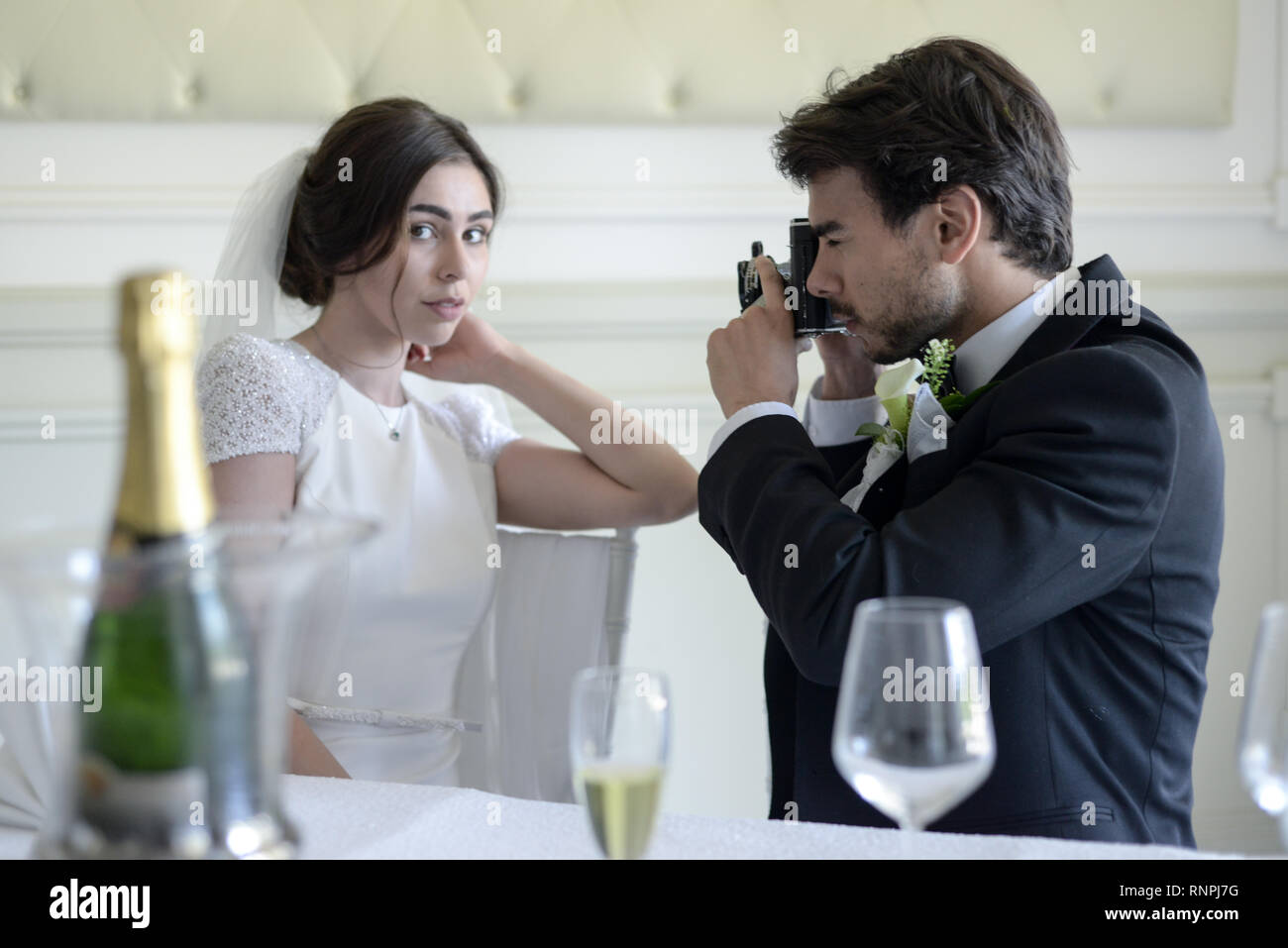 A young pensive couple have a traditional English White Wedding, they ...