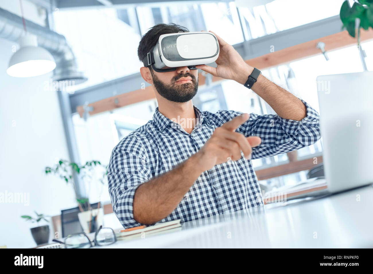 Business person using virtual reality headset serious Stock Photo - Alamy