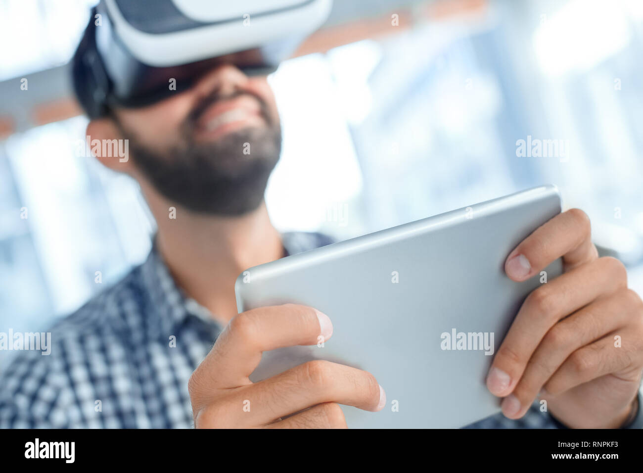 Business person using virtual reality headset holding digital tablet ...