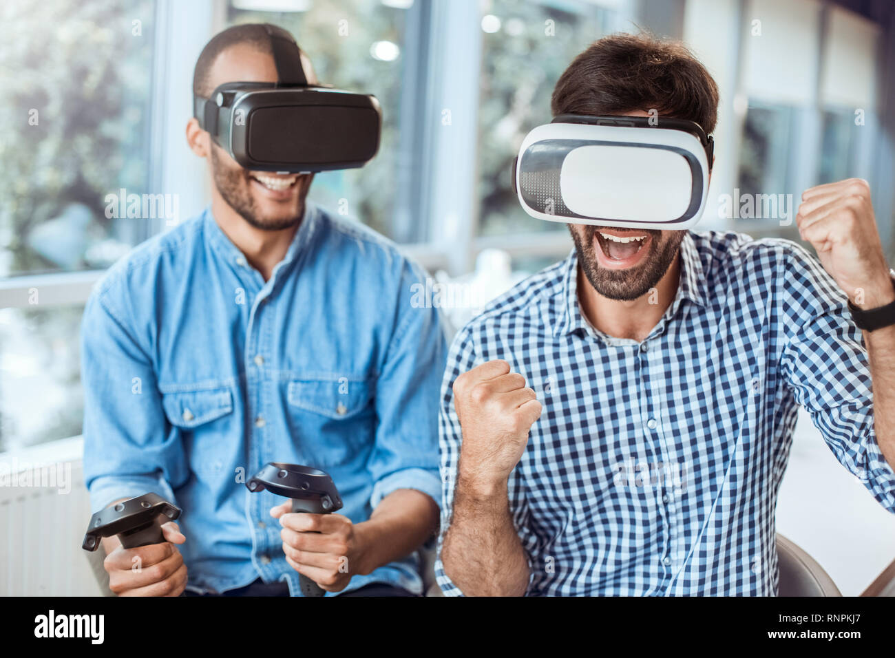 Male collegues playing hi-res stock photography and images - Alamy